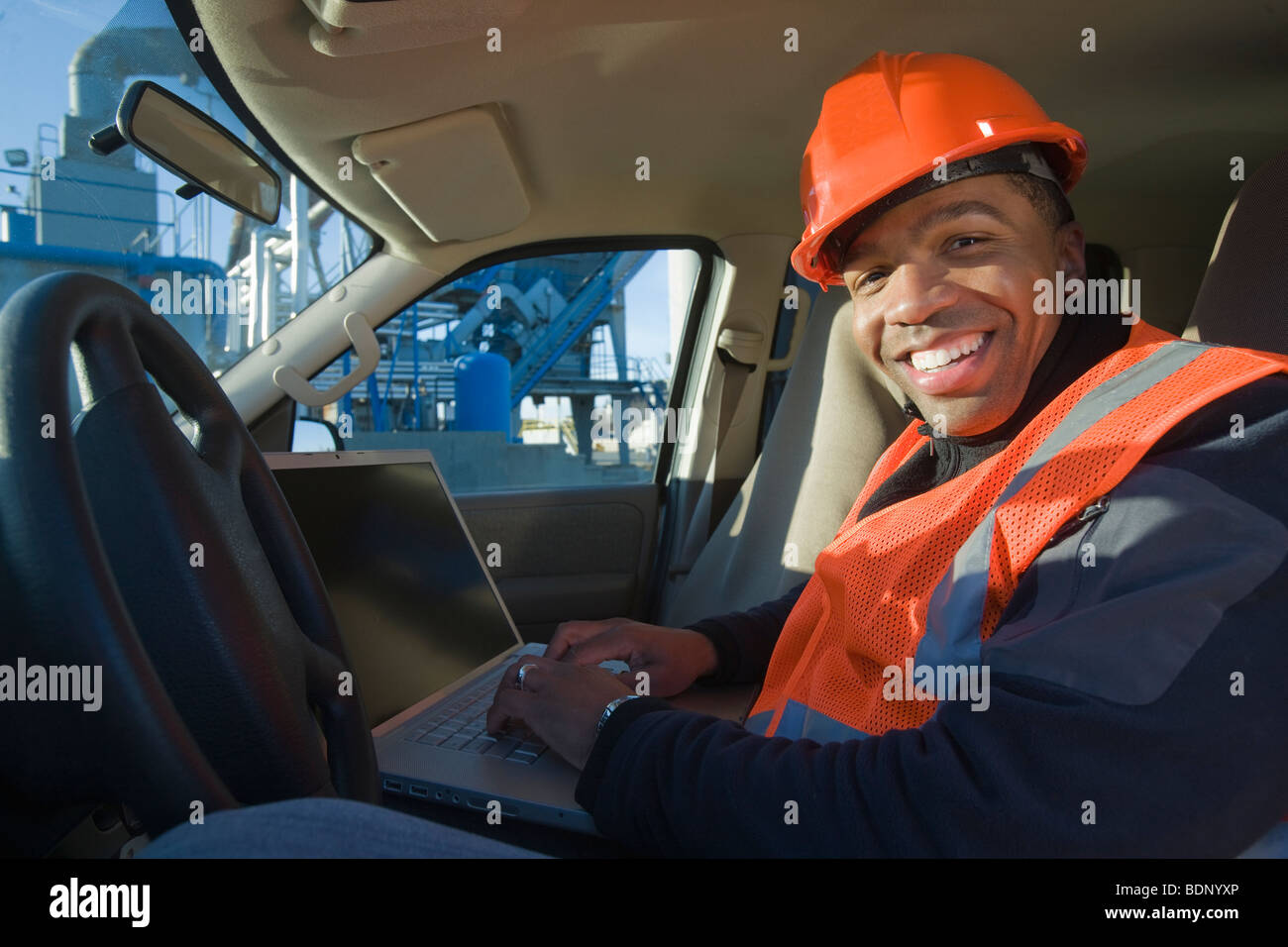 Engineer working on a laptop in a car Stock Photo - Alamy