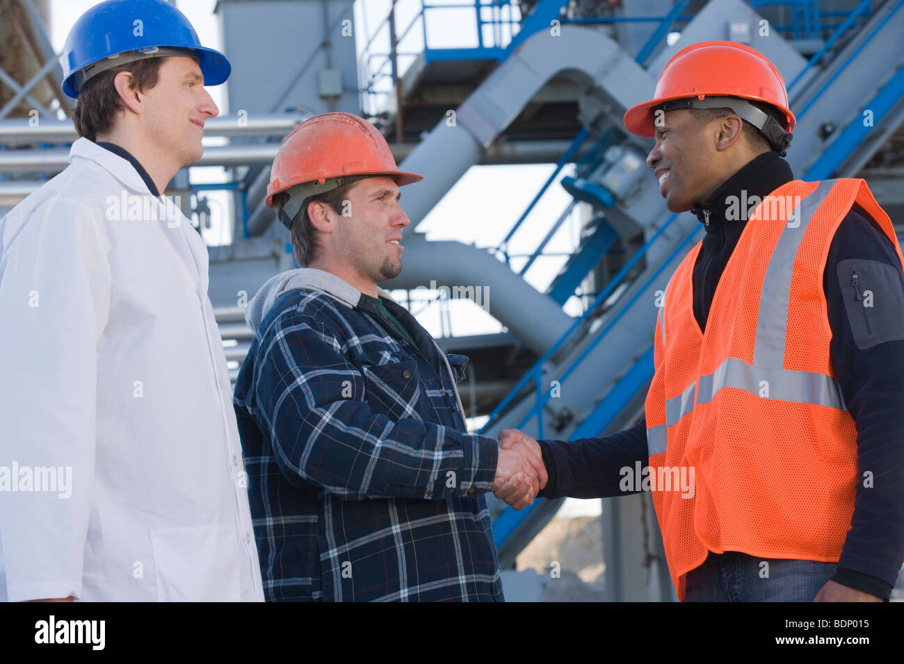 Two engineers shaking hands Stock Photo - Alamy