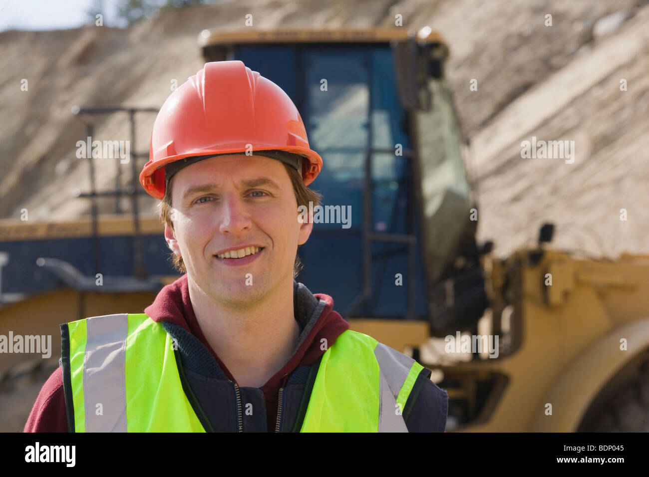 Engineer smiling at a construction site Stock Photo - Alamy