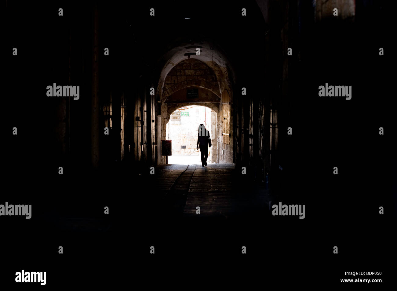 Woman walking into the light Stock Photo - Alamy