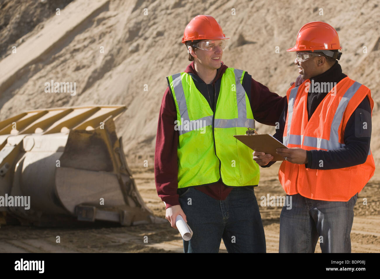 Two engineers discussing at a construction site Stock Photo - Alamy