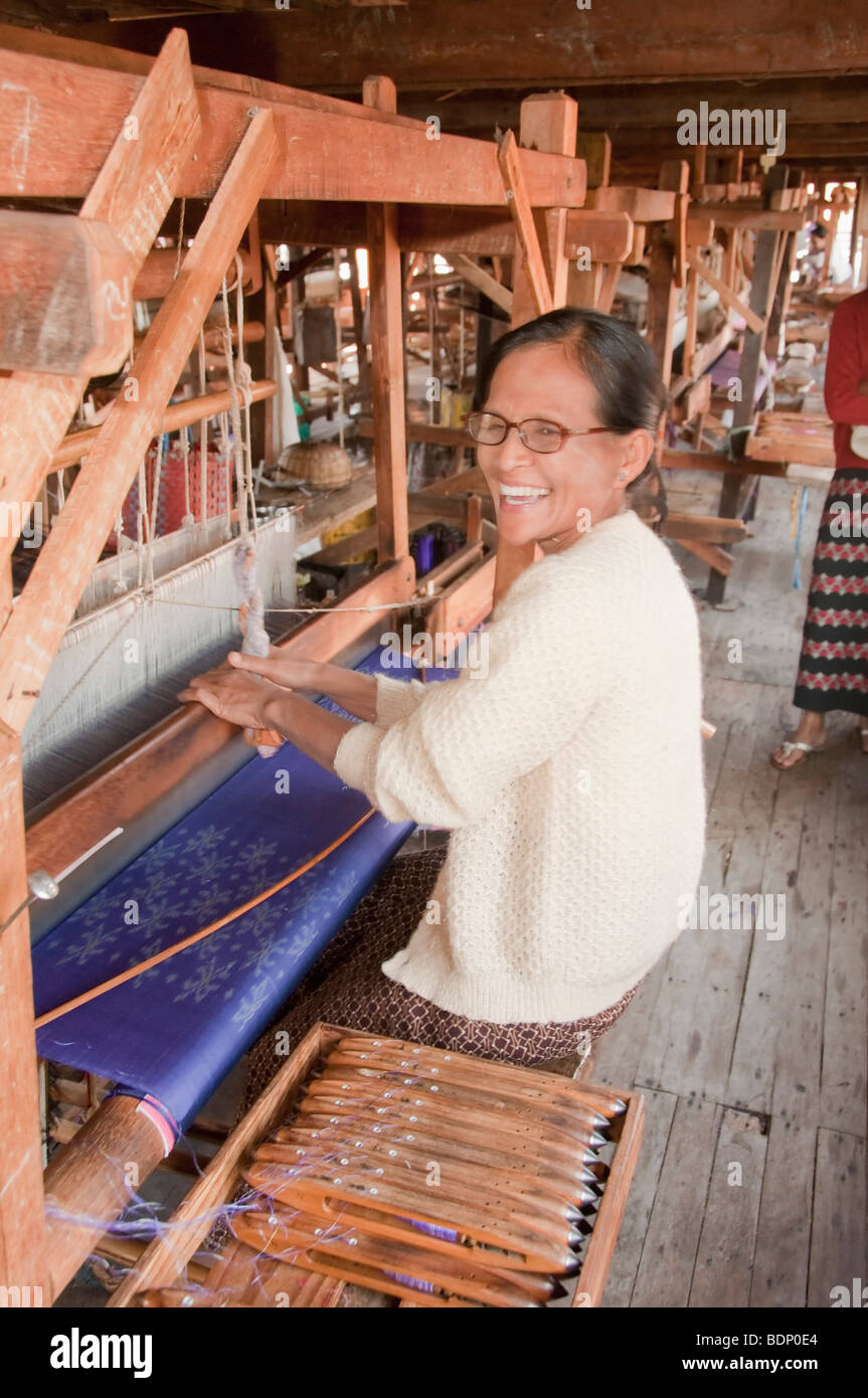 Women hand-weaving silk on wooden spinning wheels and looms Inle Lake ...