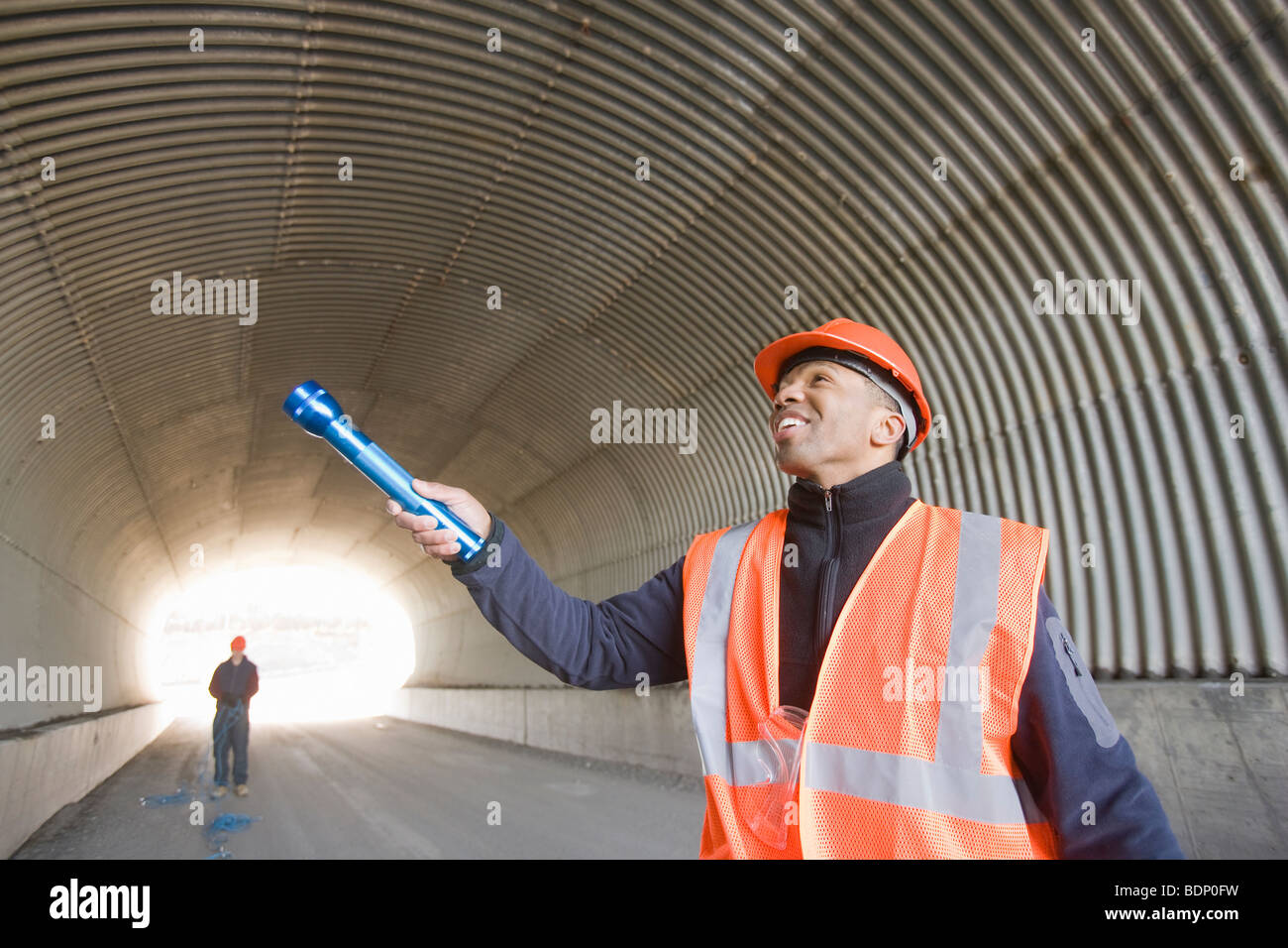 Two engineers inspecting a tunnel Stock Photo - Alamy