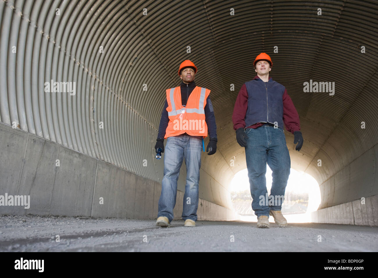 Two engineers walking in a tunnel Stock Photo - Alamy
