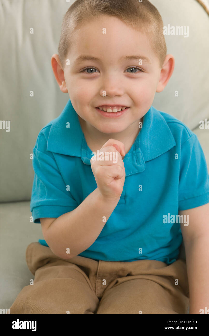 Boy signing the letter 'T' in American Sign Language Stock Photo - Alamy