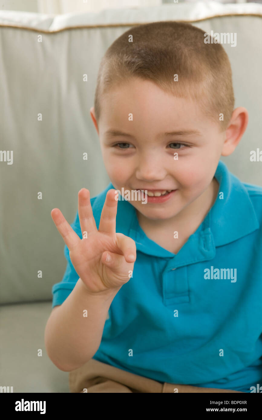 Boy signing the number '9' in American Sign Language Stock Photo - Alamy