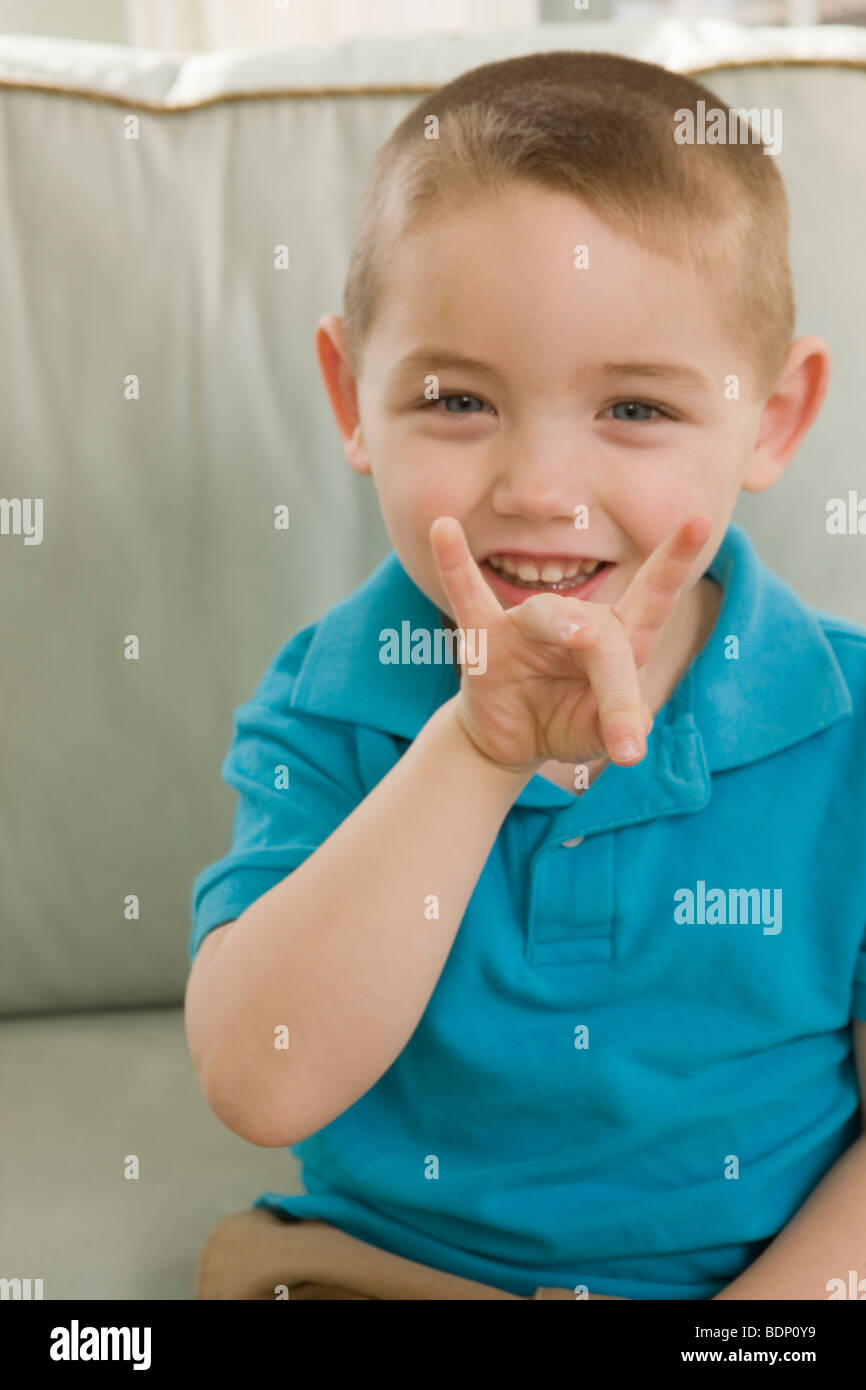Boy signing the number '8' in American Sign Language Stock Photo - Alamy