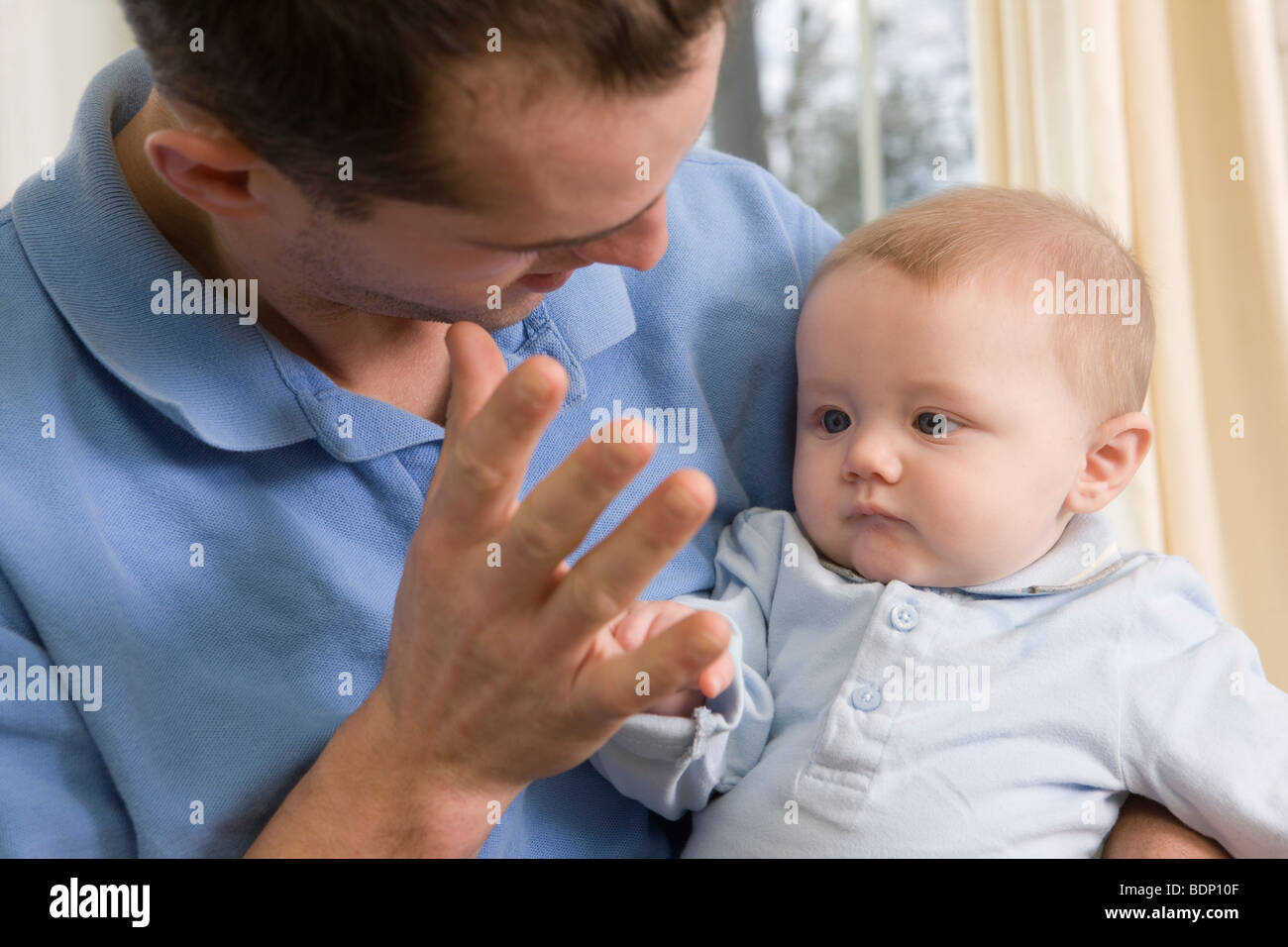 Man signing the word 'Mommy' in American Sign Language while ...