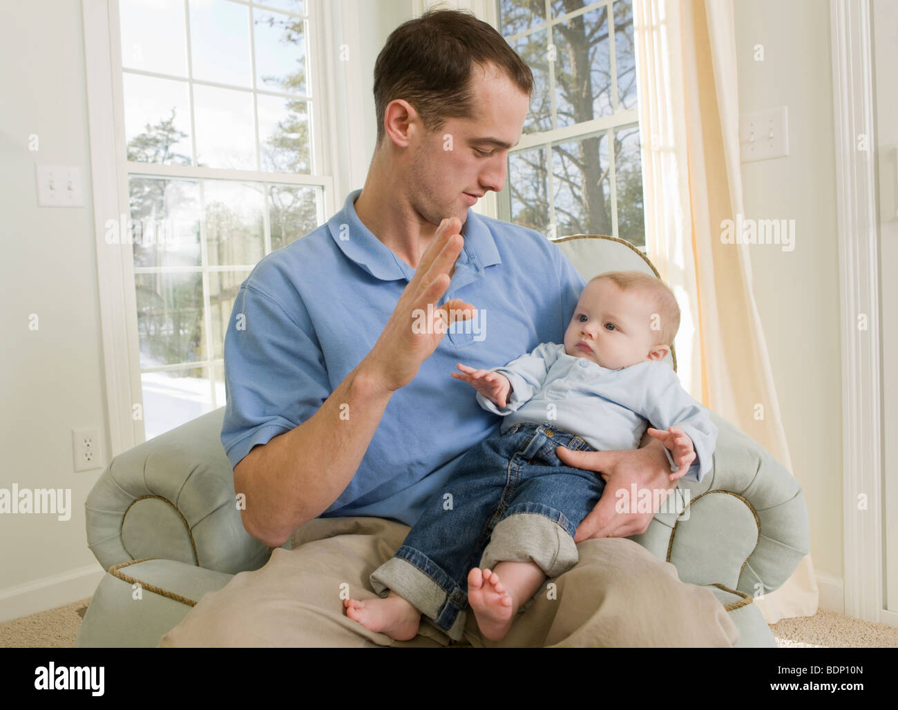 Man signing the word 'B' in American Sign Language while communicating ...