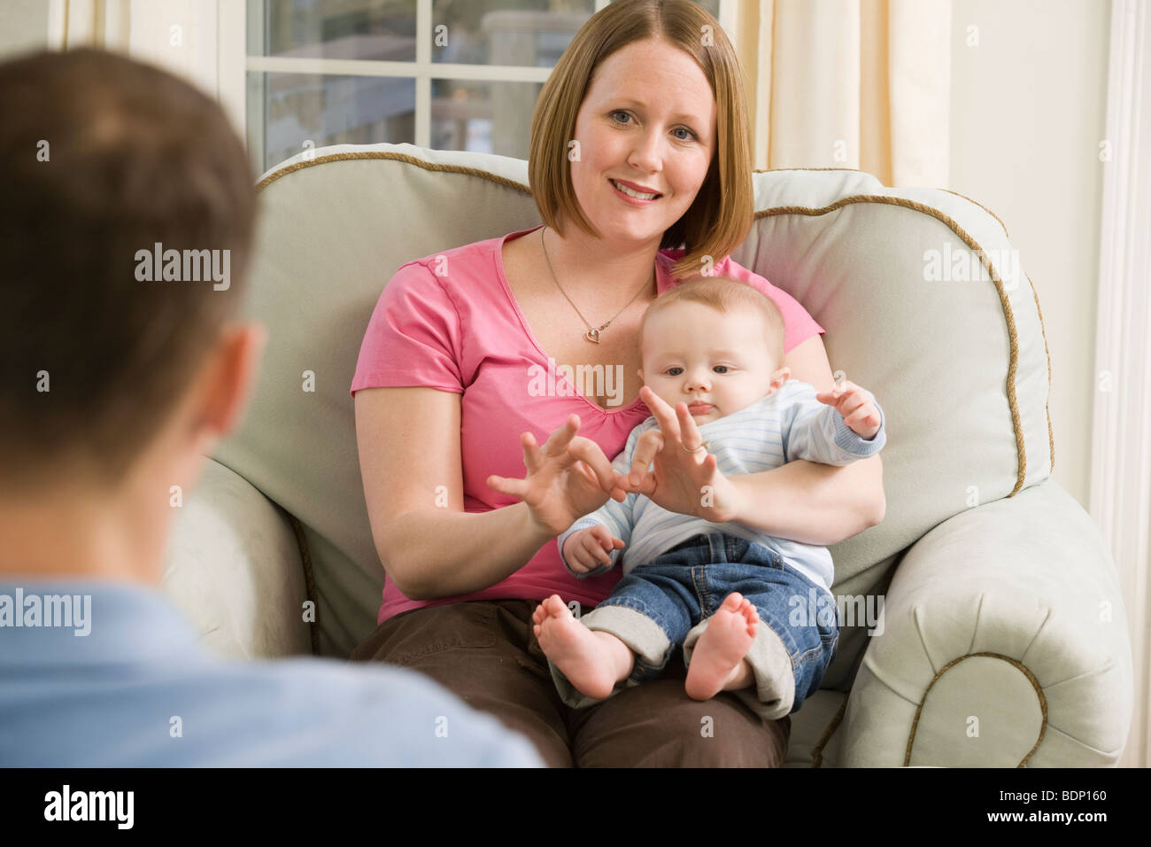 Woman signing the word 'Family' in American Sign Language while ...