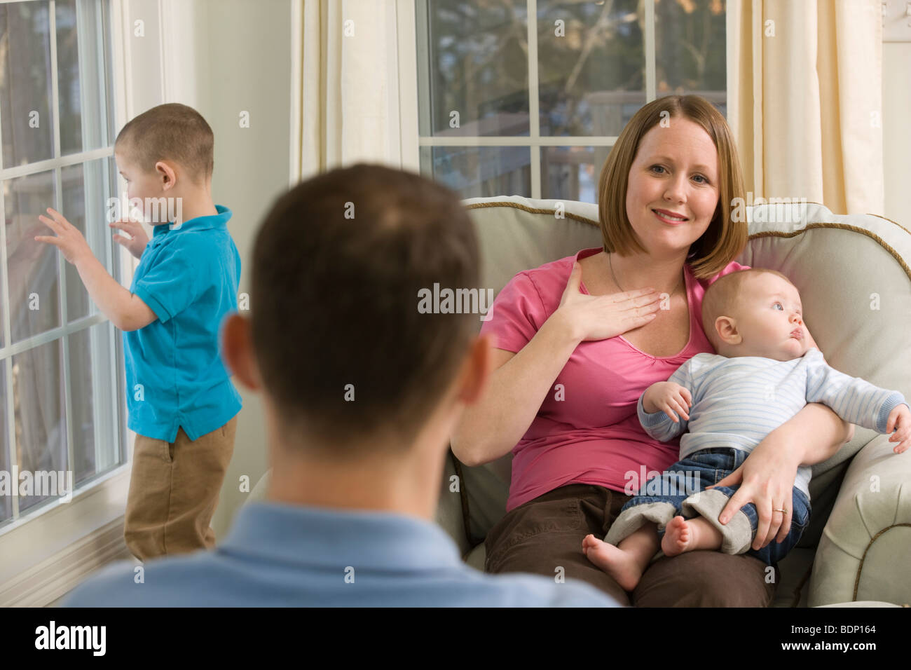 Woman signing the word 'Happy' in American Sign Language while ...