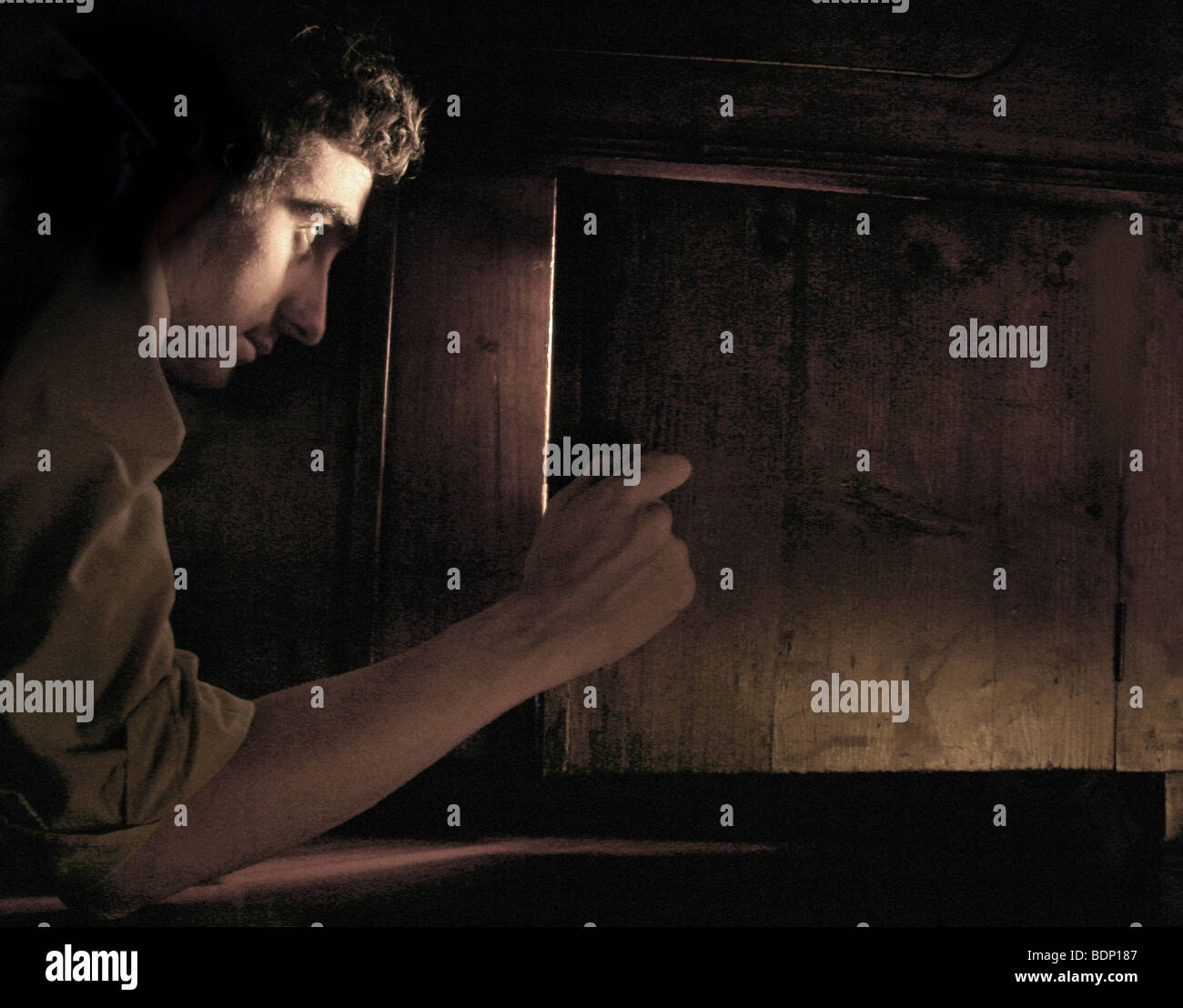 Peering through a door hi-res stock photography and images - Alamy