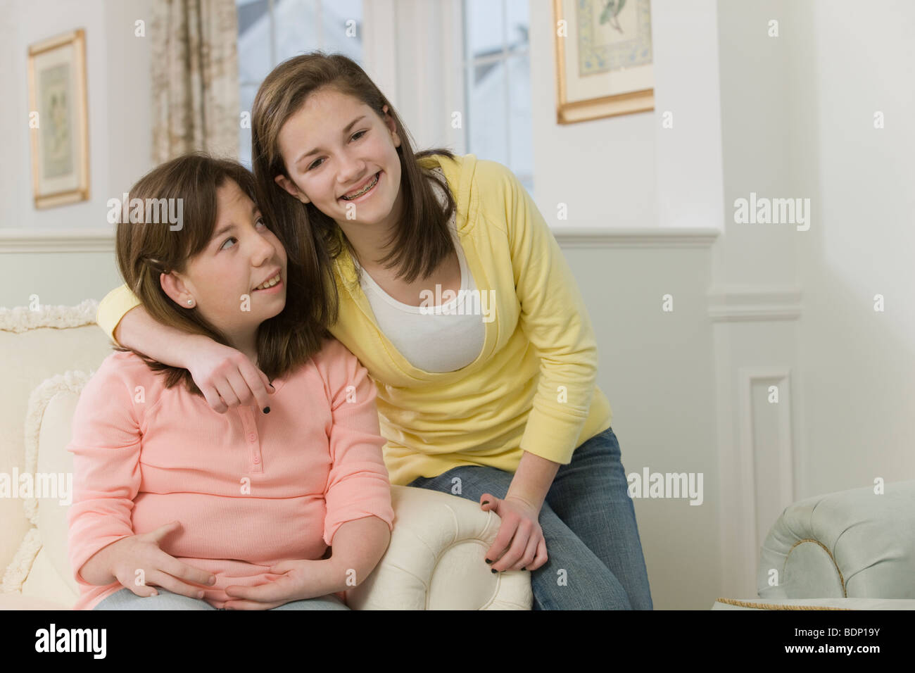 Two teenage girls smiling together Stock Photo - Alamy