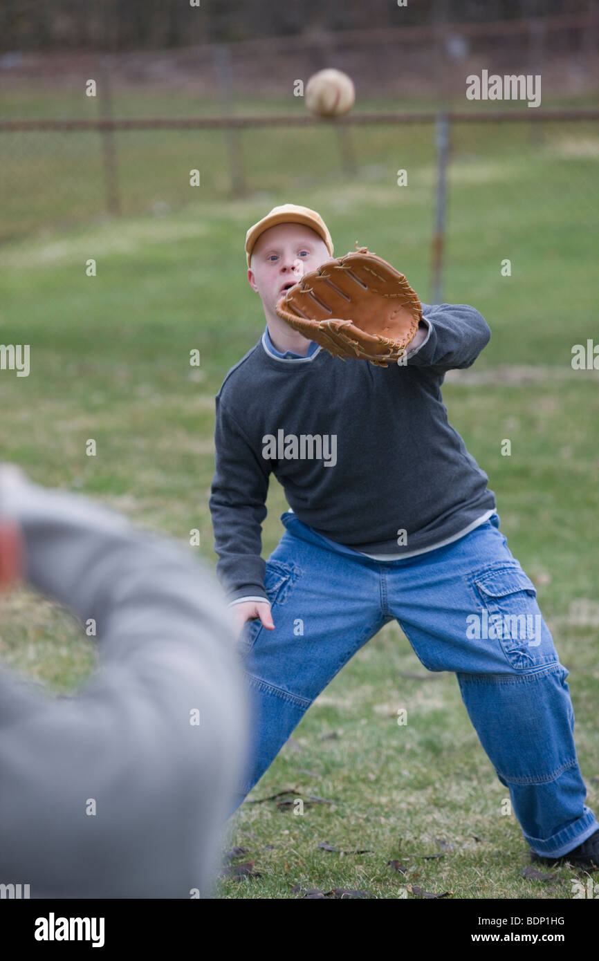 Disabled man playing baseball with his son Stock Photo - Alamy