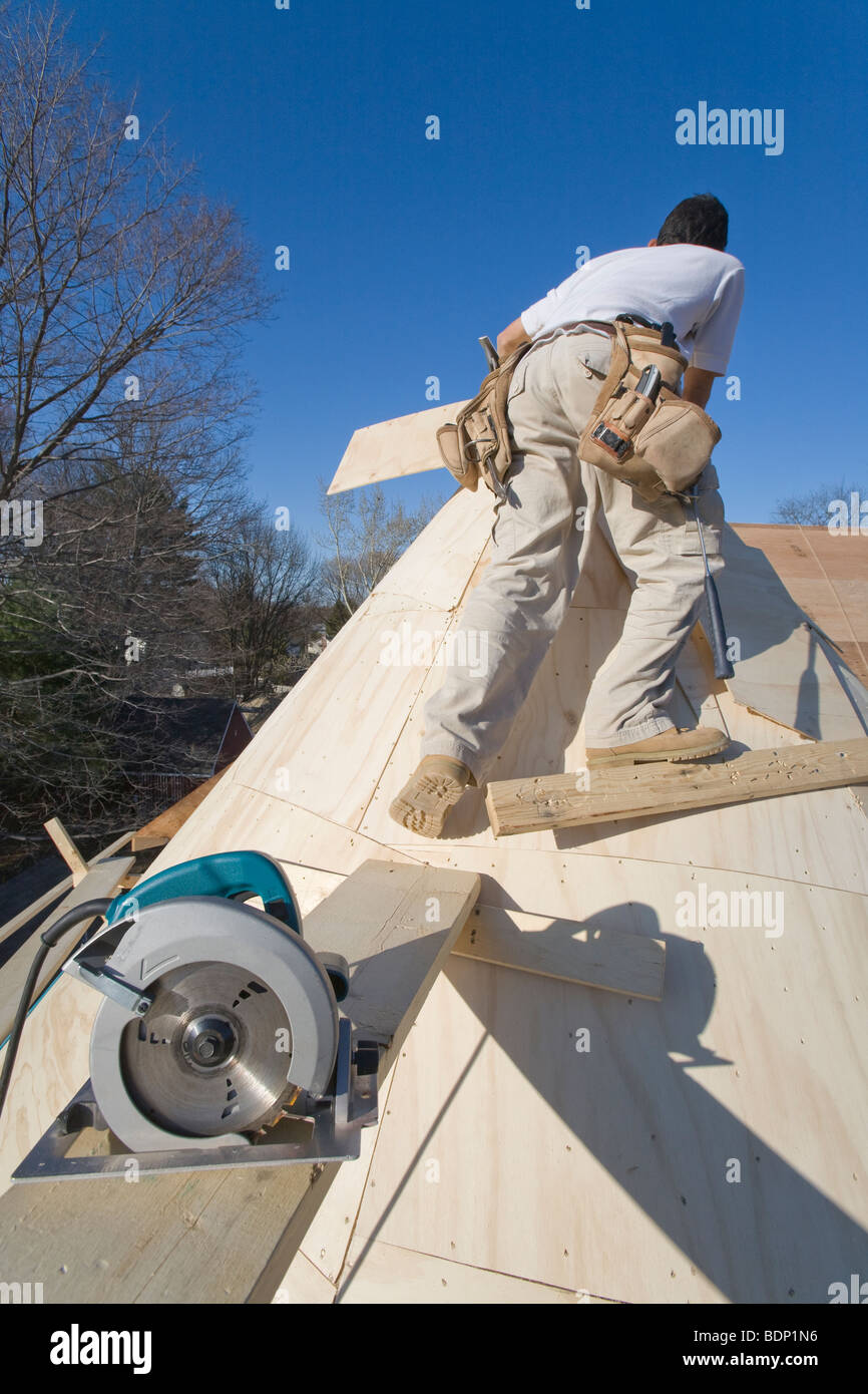 Carpenter working on the turret of a house Stock Photo - Alamy