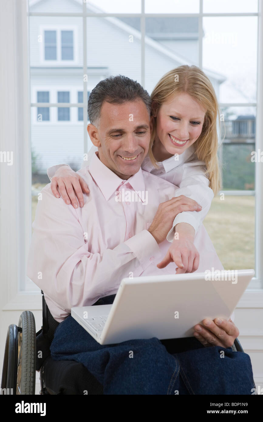 Couple working on a laptop Stock Photo - Alamy