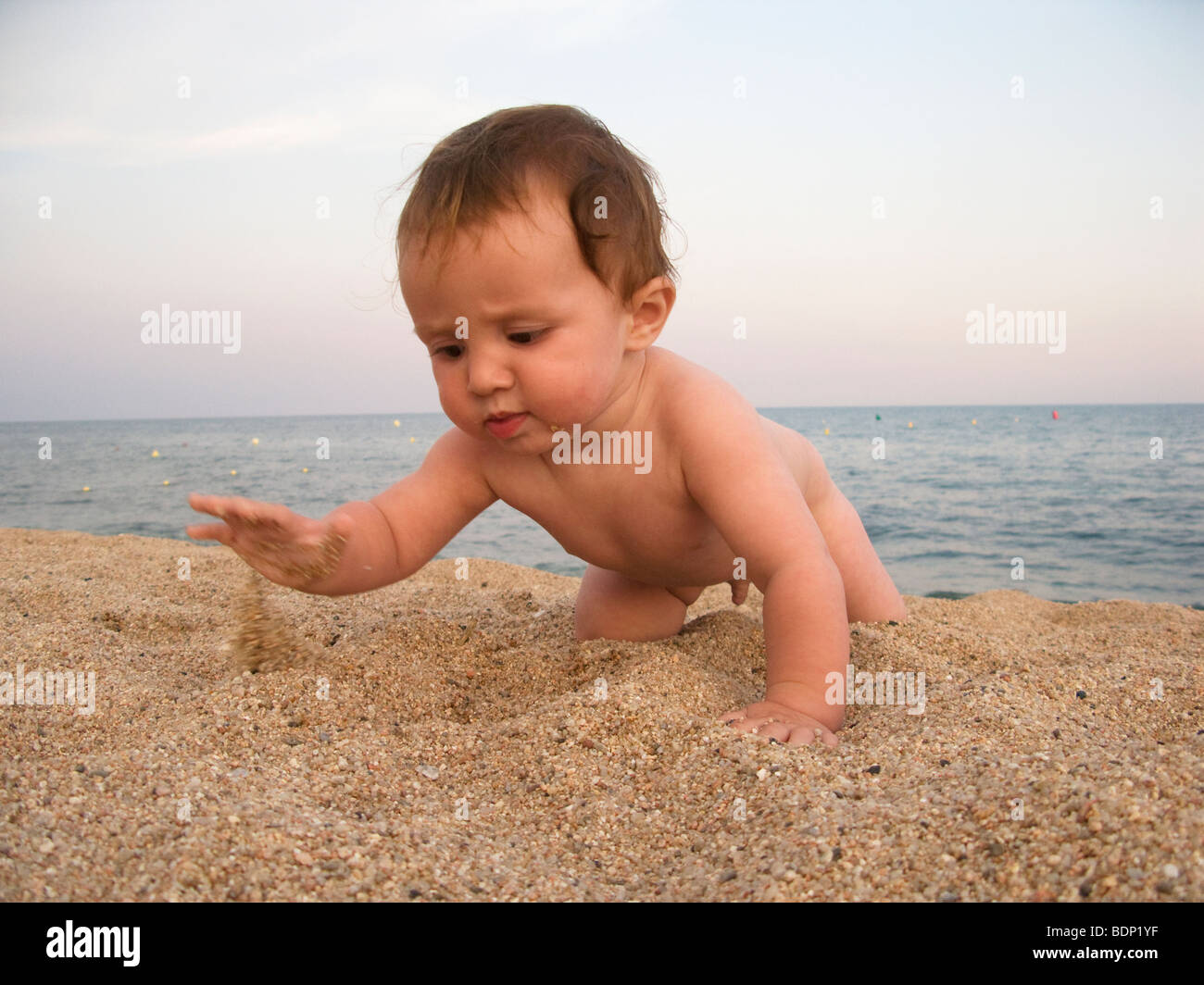 bay boy playing with the sand on the beach Stock Photo - Alamy