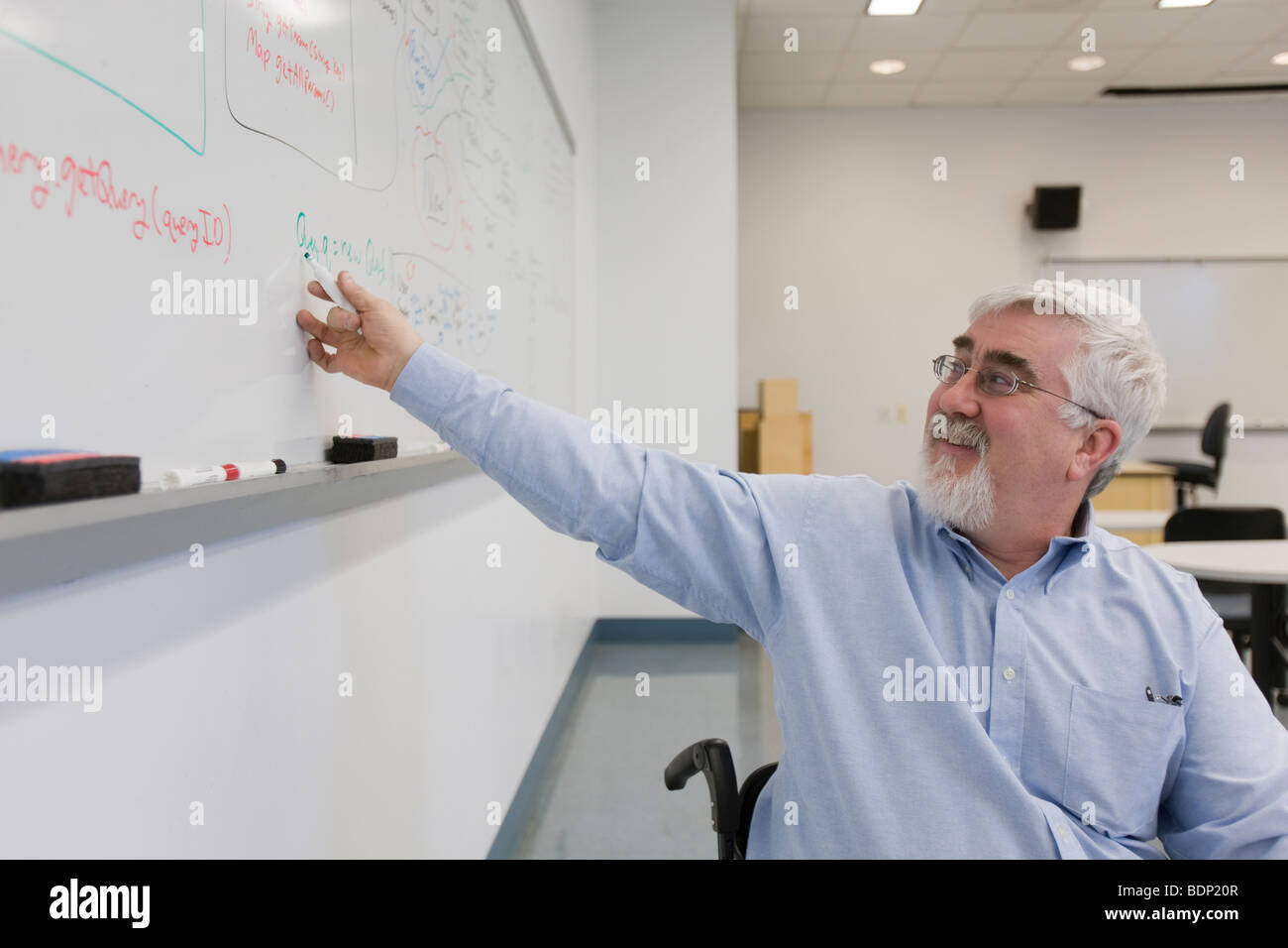 University professor writing on a whiteboard in a classroom Stock Photo ...
