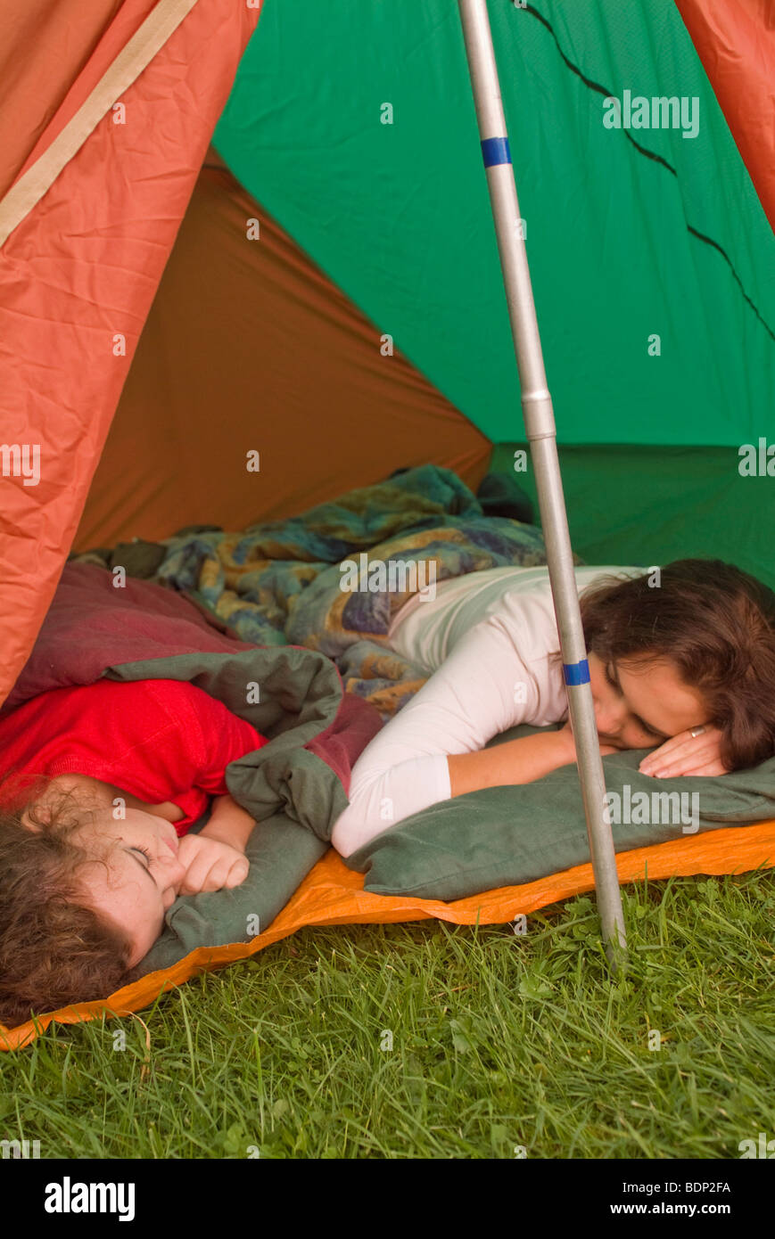 Two teenage girls camping in a pup tent Stock Photo - Alamy