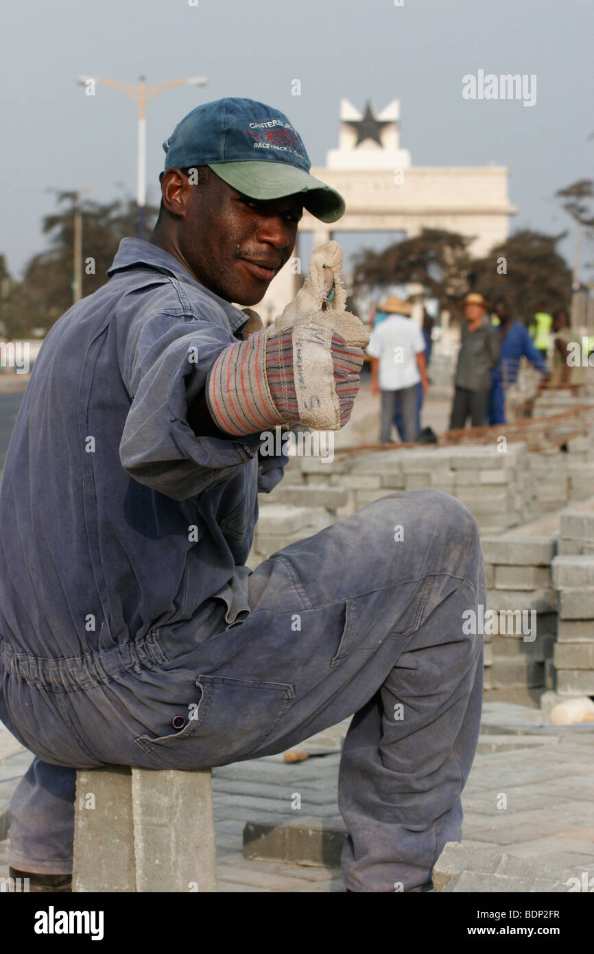 Road workers led by Chinese foreman repair the pavement near ...