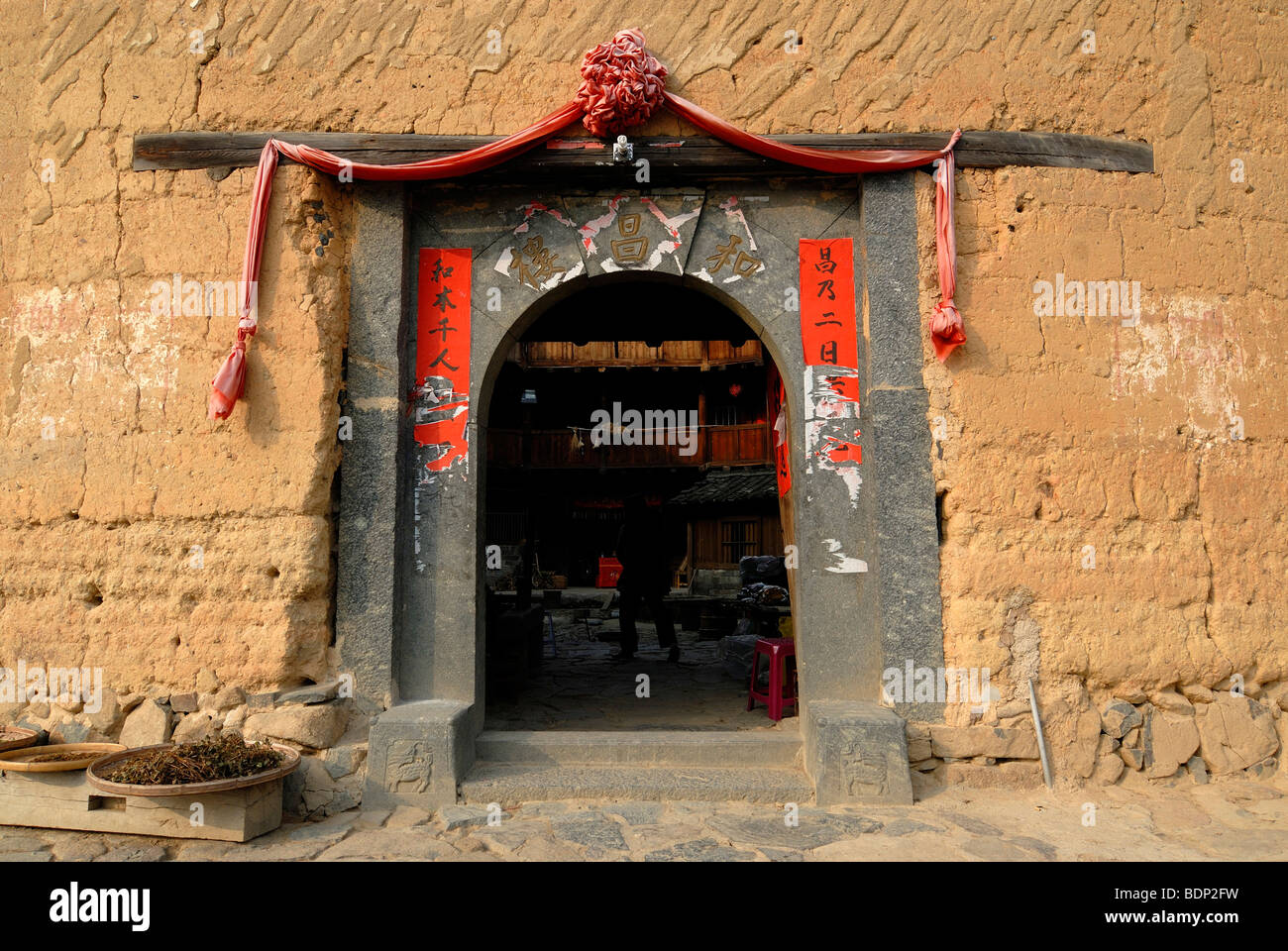 Decorated archway of a round house, Chinese: Tulou, adobe round house ...
