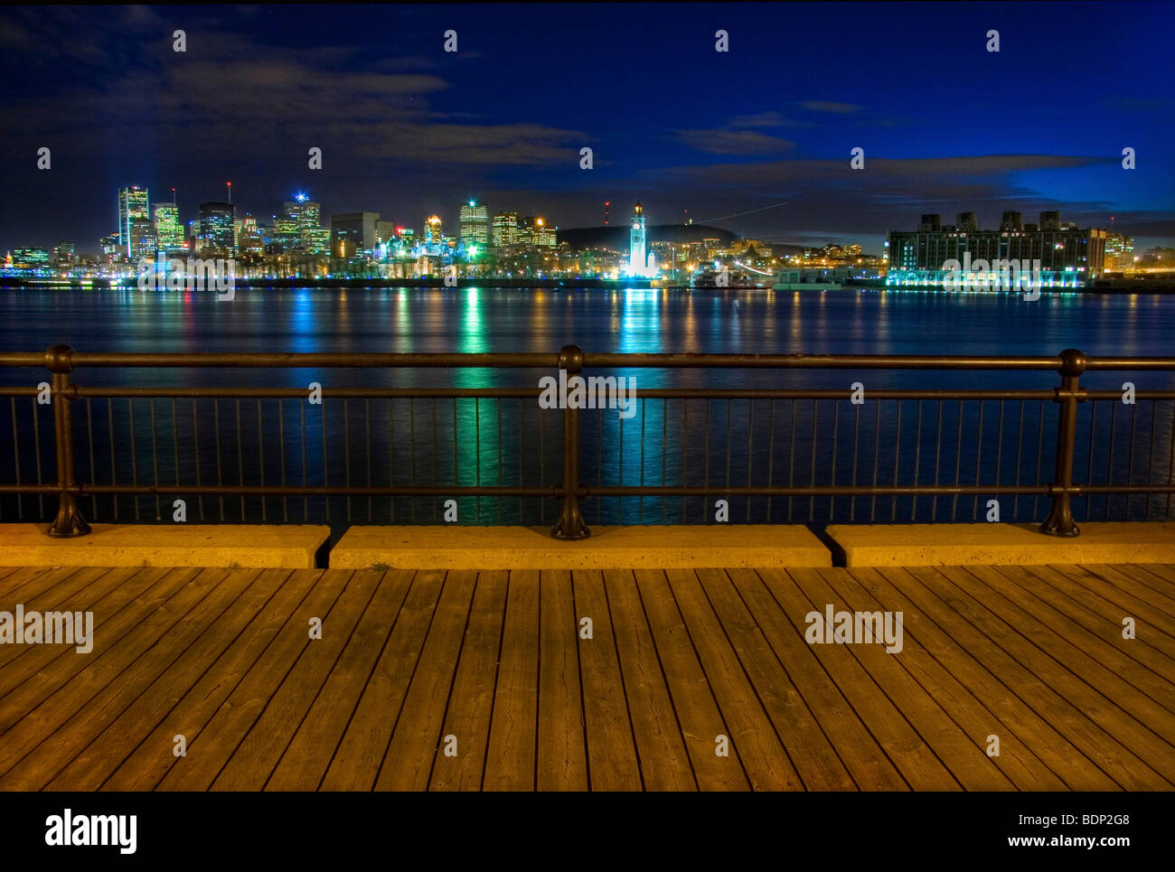An urban lakeside scene at night from a wooden jetty Stock Photo - Alamy