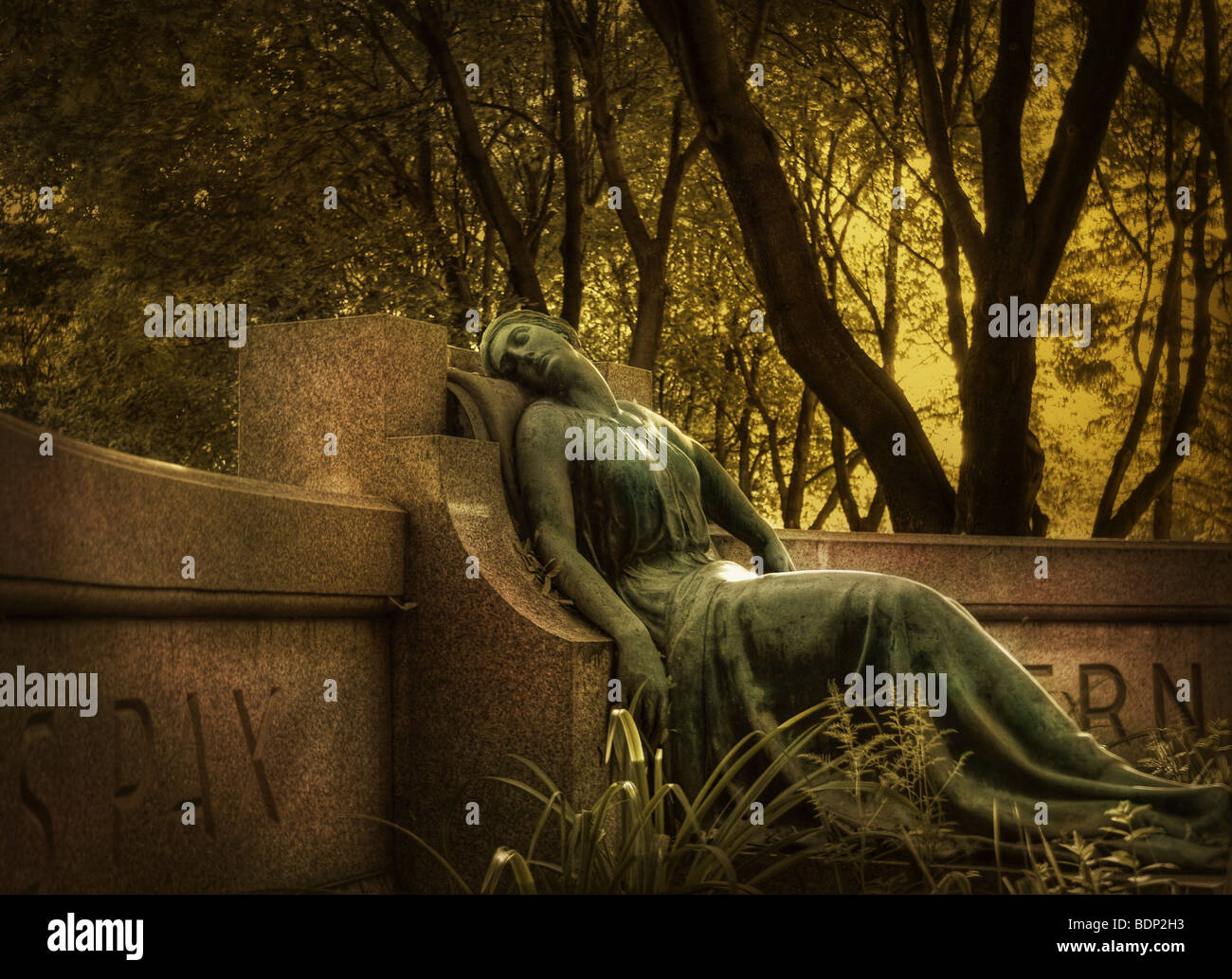 A memorial with sleeping statue in woods Stock Photo - Alamy