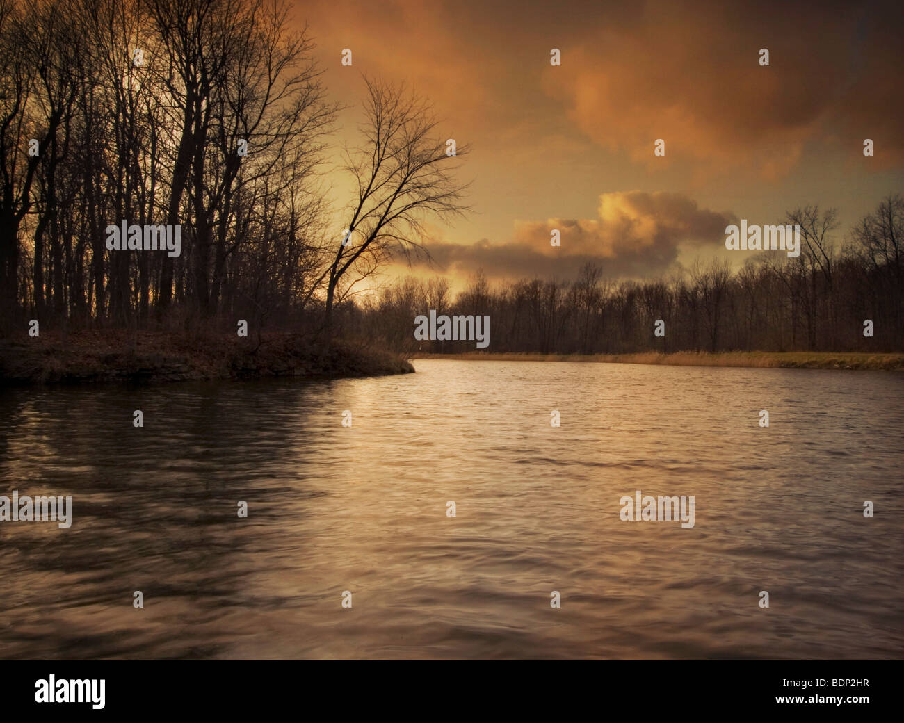 Sunrise over a river with trees Stock Photo - Alamy