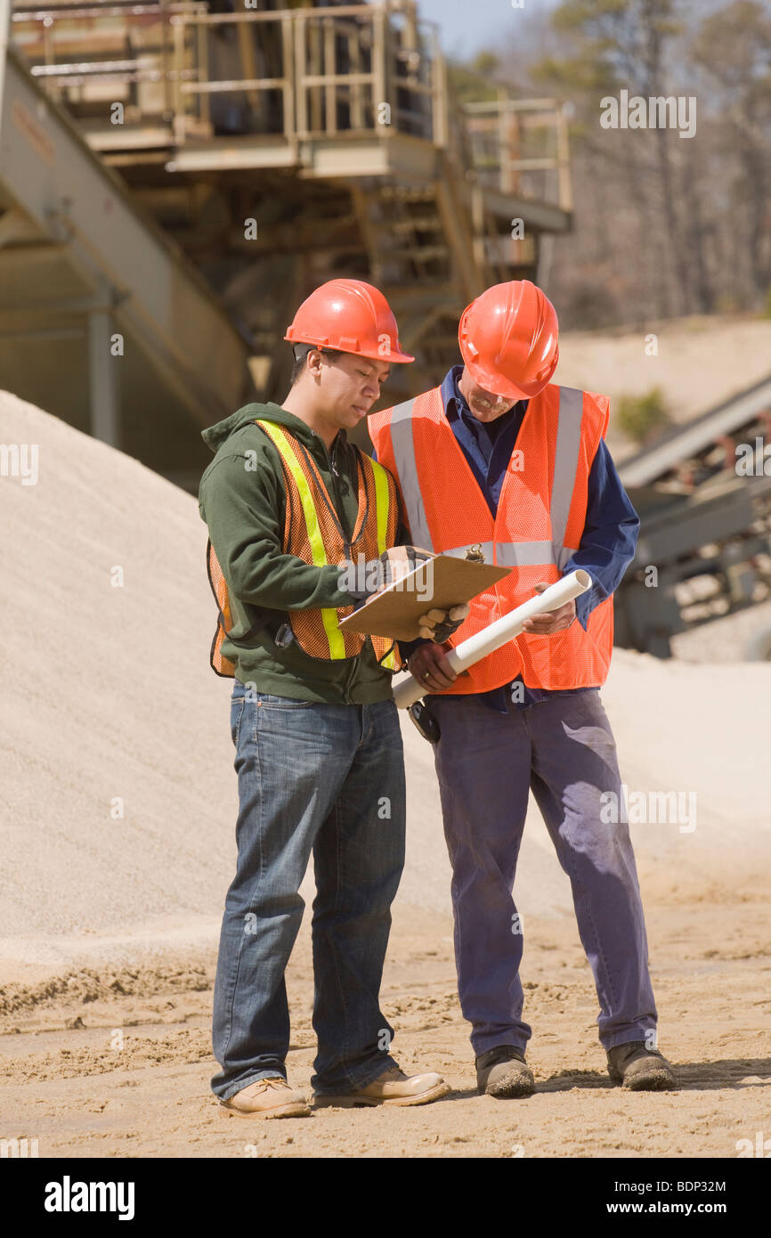 Two engineers discussing at a plant Stock Photo - Alamy