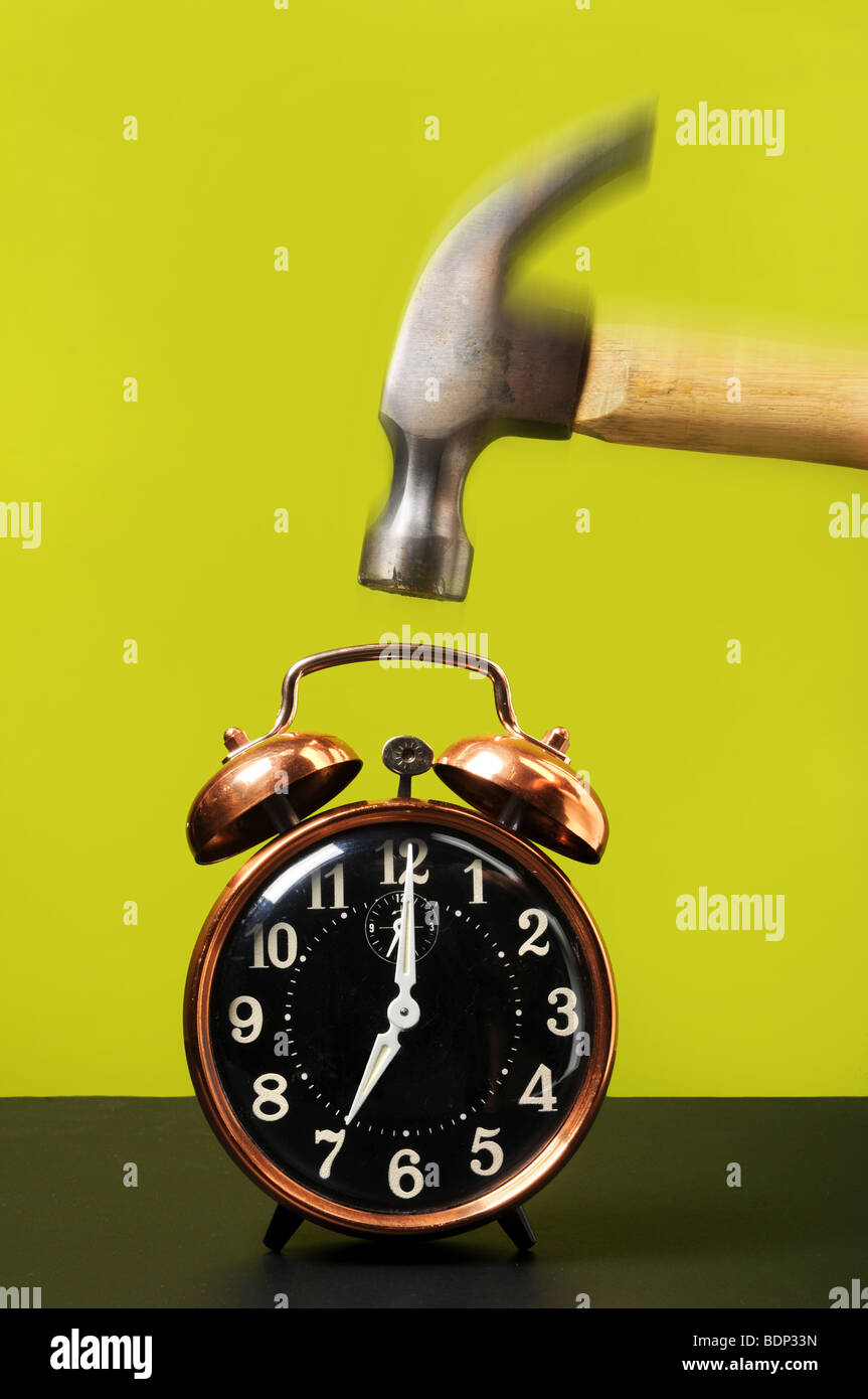 Vintage alarm clock and hammer falling Stock Photo - Alamy