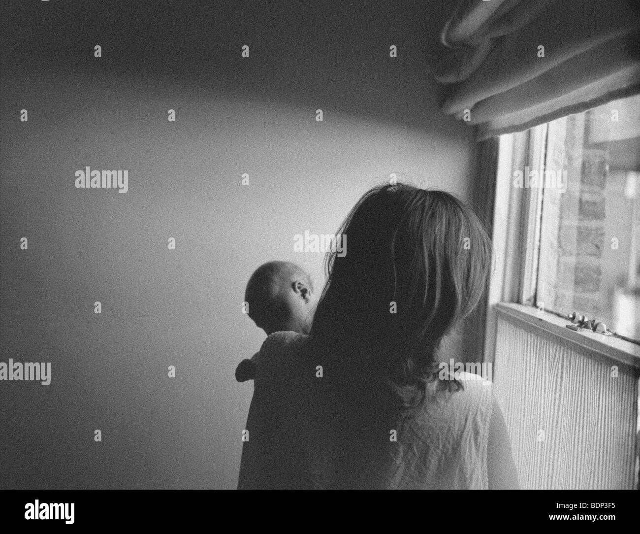 Baby looking out window Black and White Stock Photos & Images - Alamy