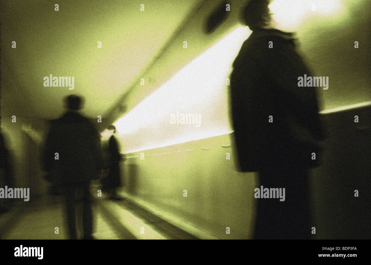 Men standing in front of a long urinal Stock Photo - Alamy
