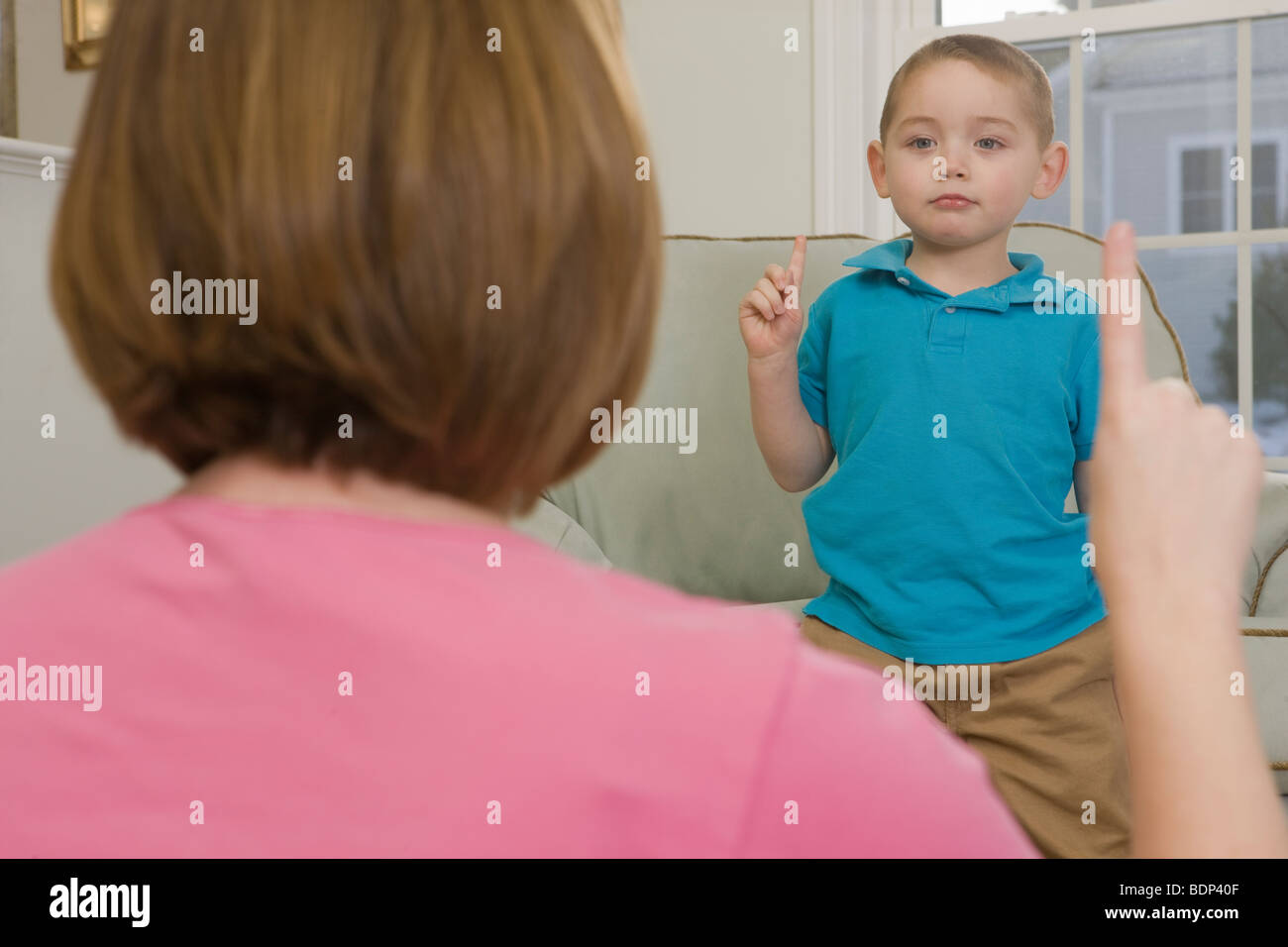Woman signing the number '1' in American Sign Language while ...