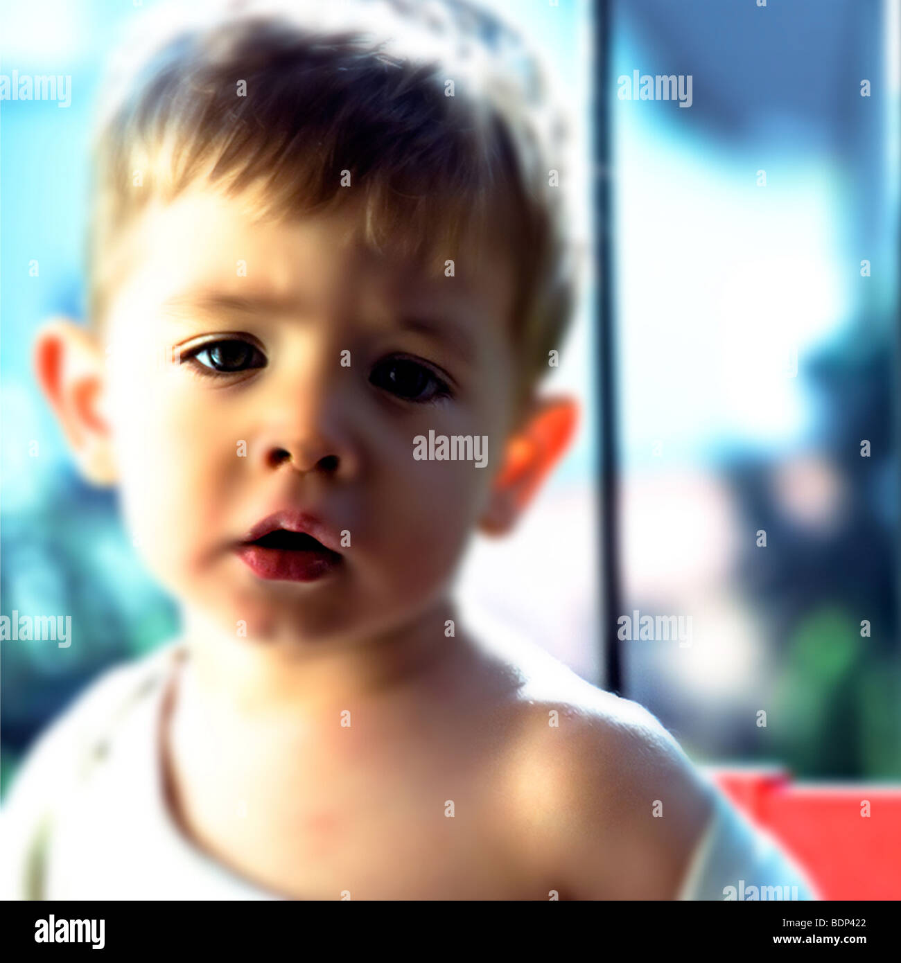 A young boy with a sad expression looking at camera Stock Photo - Alamy