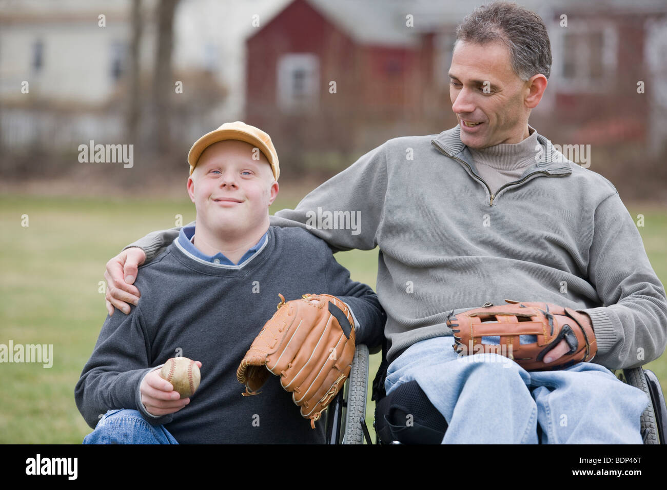 Disabled man smiling with his son Stock Photo - Alamy