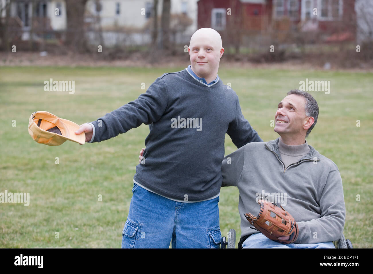 Disabled man smiling with his son Stock Photo - Alamy