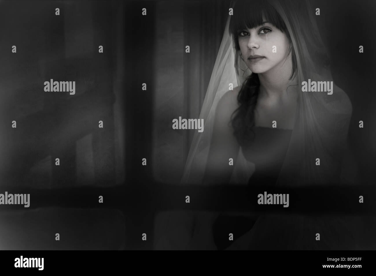 fantasy image of a young woman sitting crying Stock Photo - Alamy