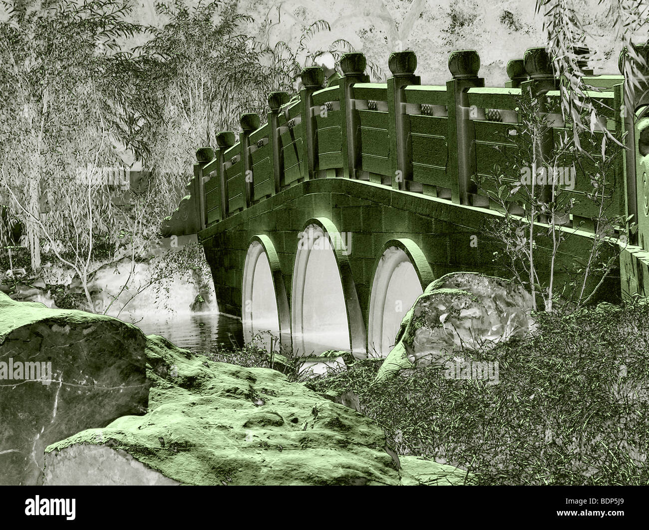 A stone bridge crosses a misty lake lined with willow trees on its way ...