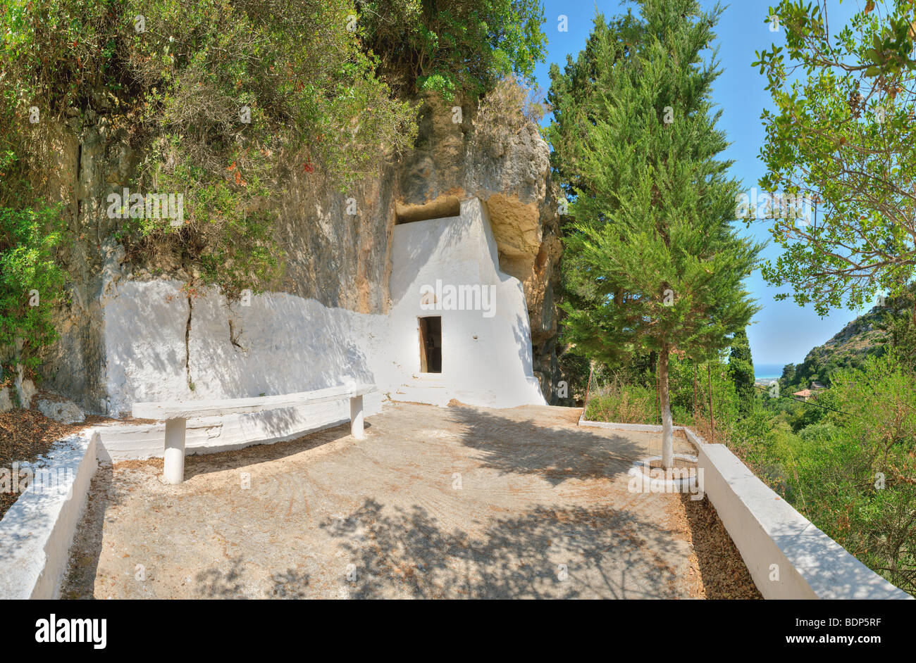 Whitewashed Greek chapel built into the rock face Stock Photo - Alamy