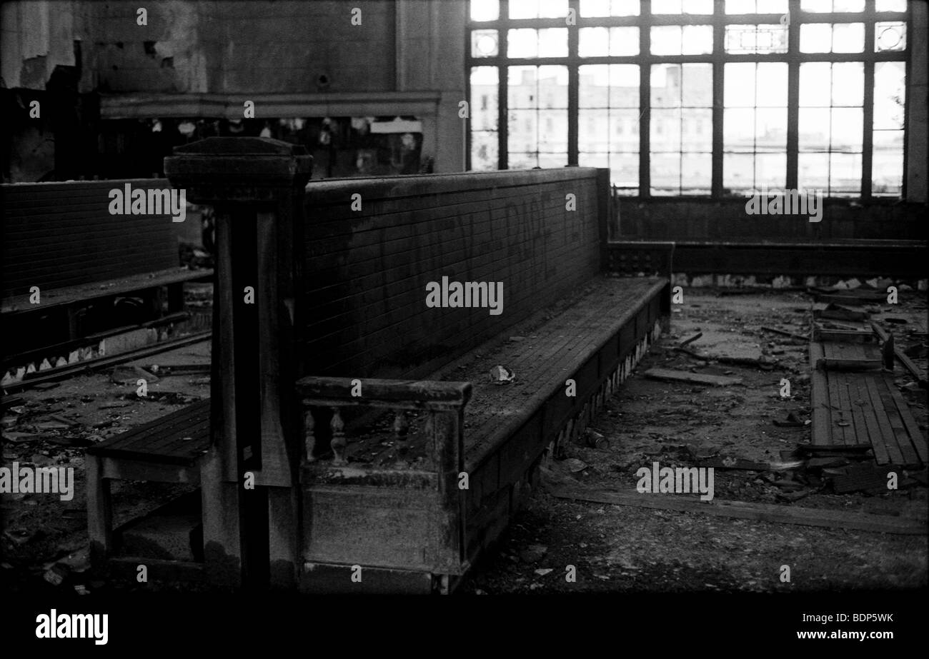 Wooden benches collecting dust in an abandoned railroad station's ...