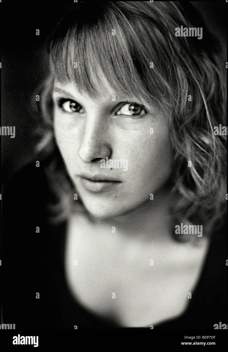 A young woman with blonde hair and strong eyes looking at camera Stock ...