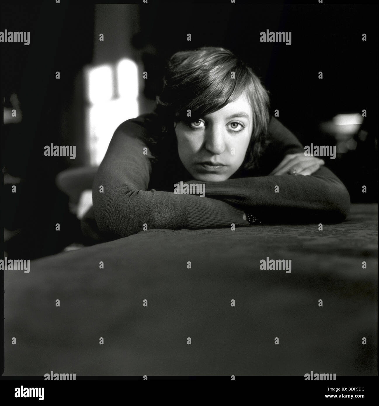 A woman resting looking directly into the camera Stock Photo - Alamy