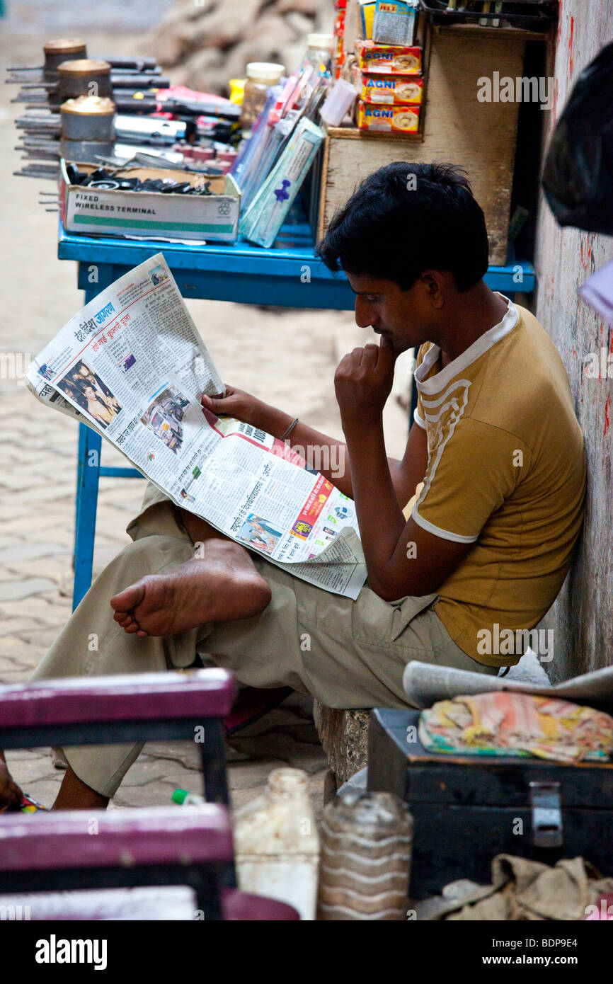 Reading newspaper in Calcutta India Stock Photo - Alamy