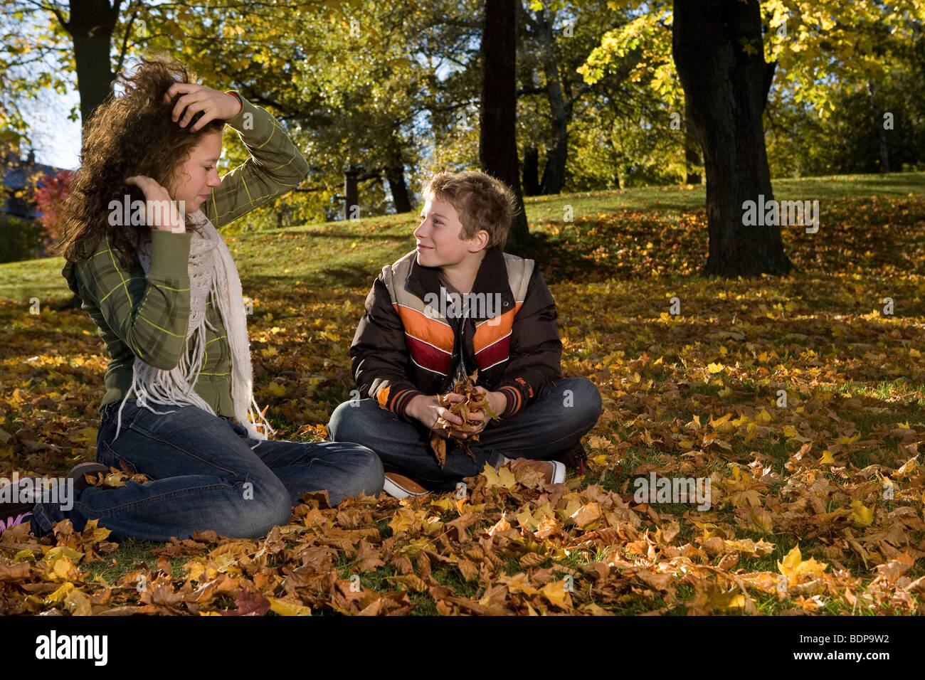 Brother and sister talking in a park Sweden Stock Photo - Alamy