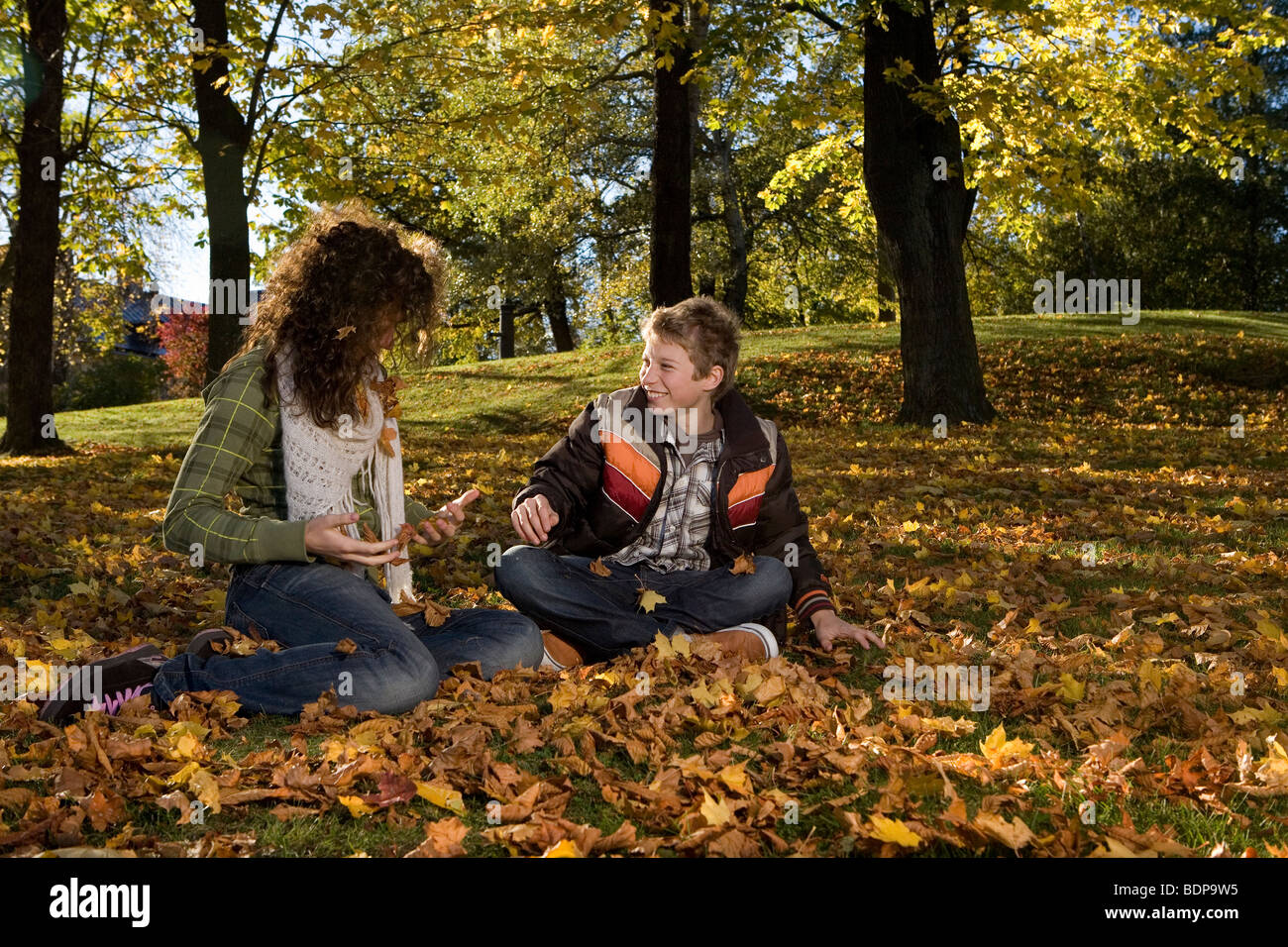 Brother and sister talking in a park Sweden Stock Photo - Alamy