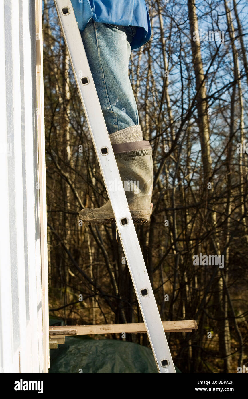 A man climbing up a ladder Sweden Stock Photo - Alamy