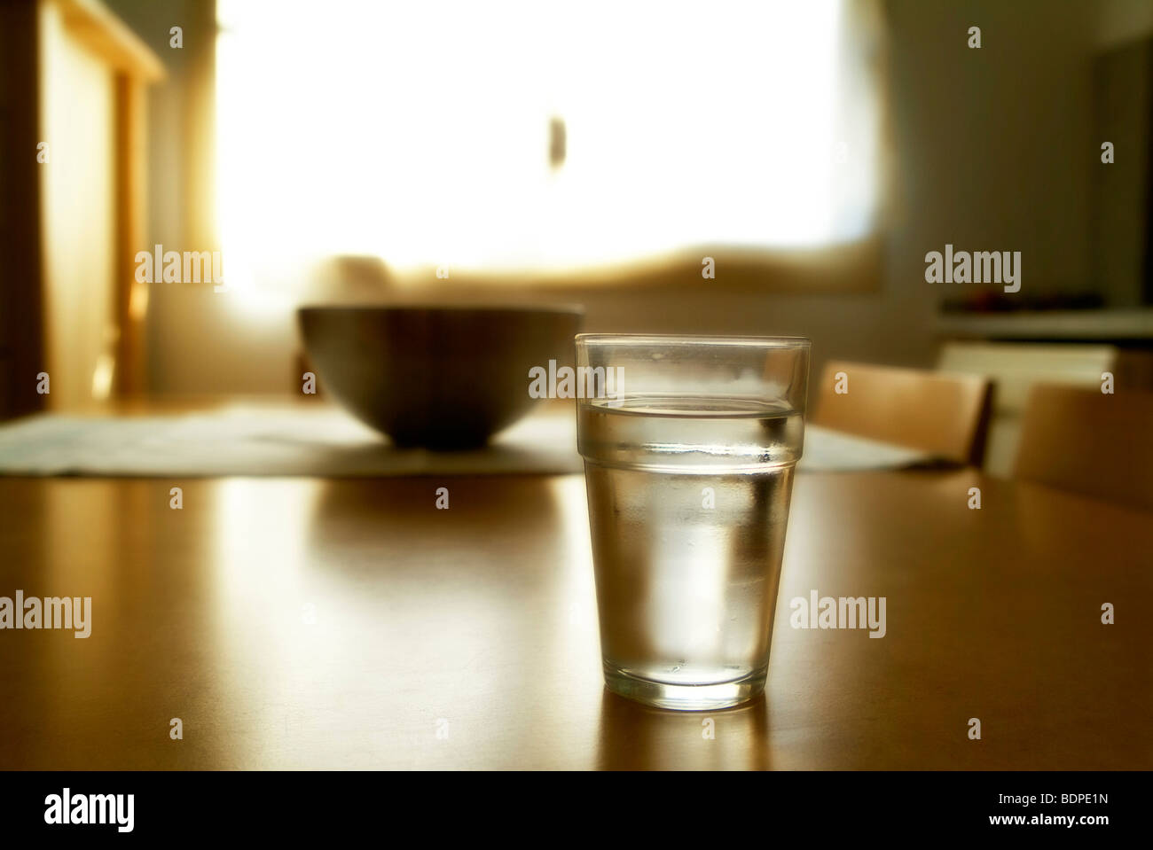 Glass of water on the kitchen's table Stock Photo - Alamy
