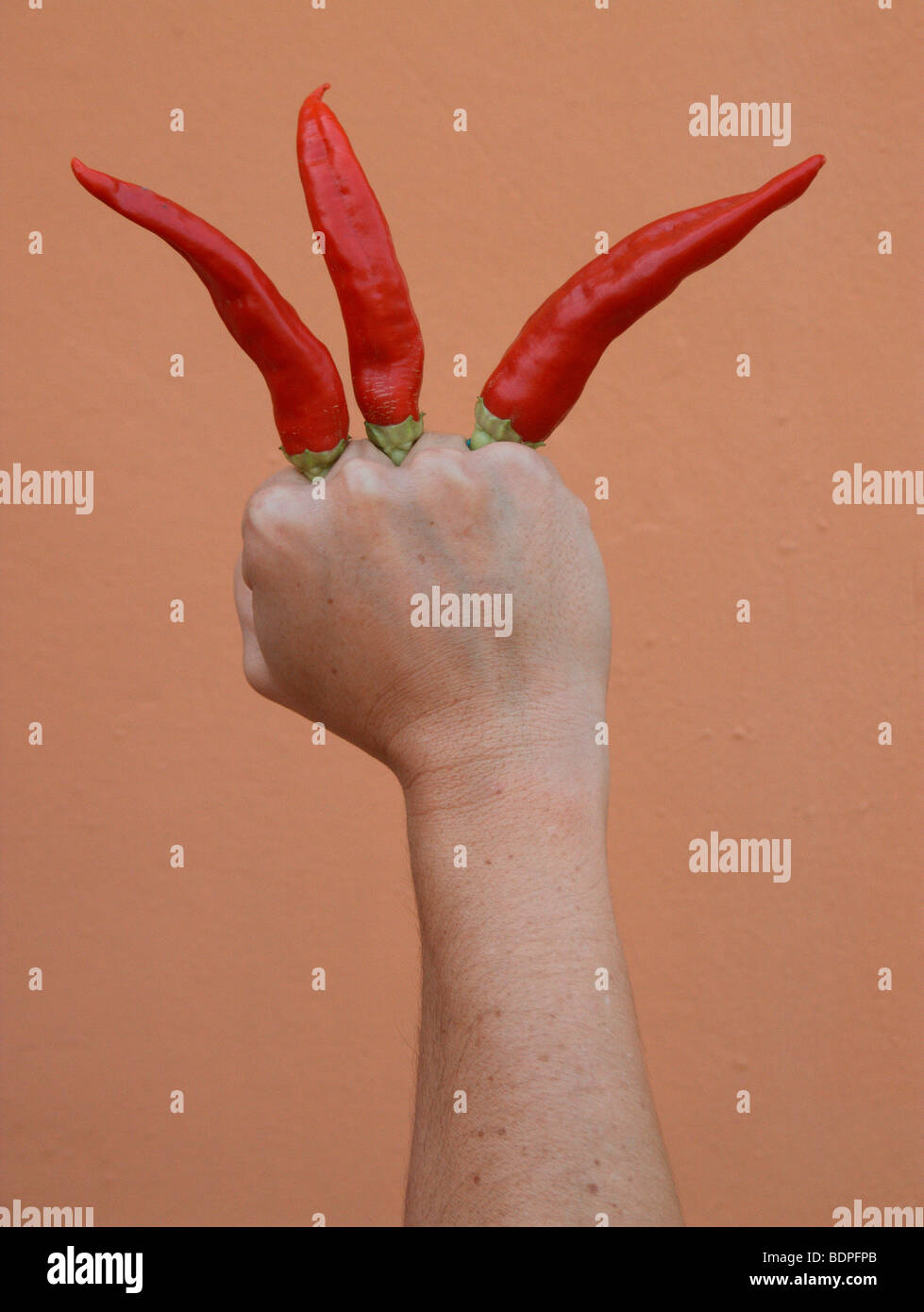 Hand with red cayenne (chili peppers Stock Photo - Alamy