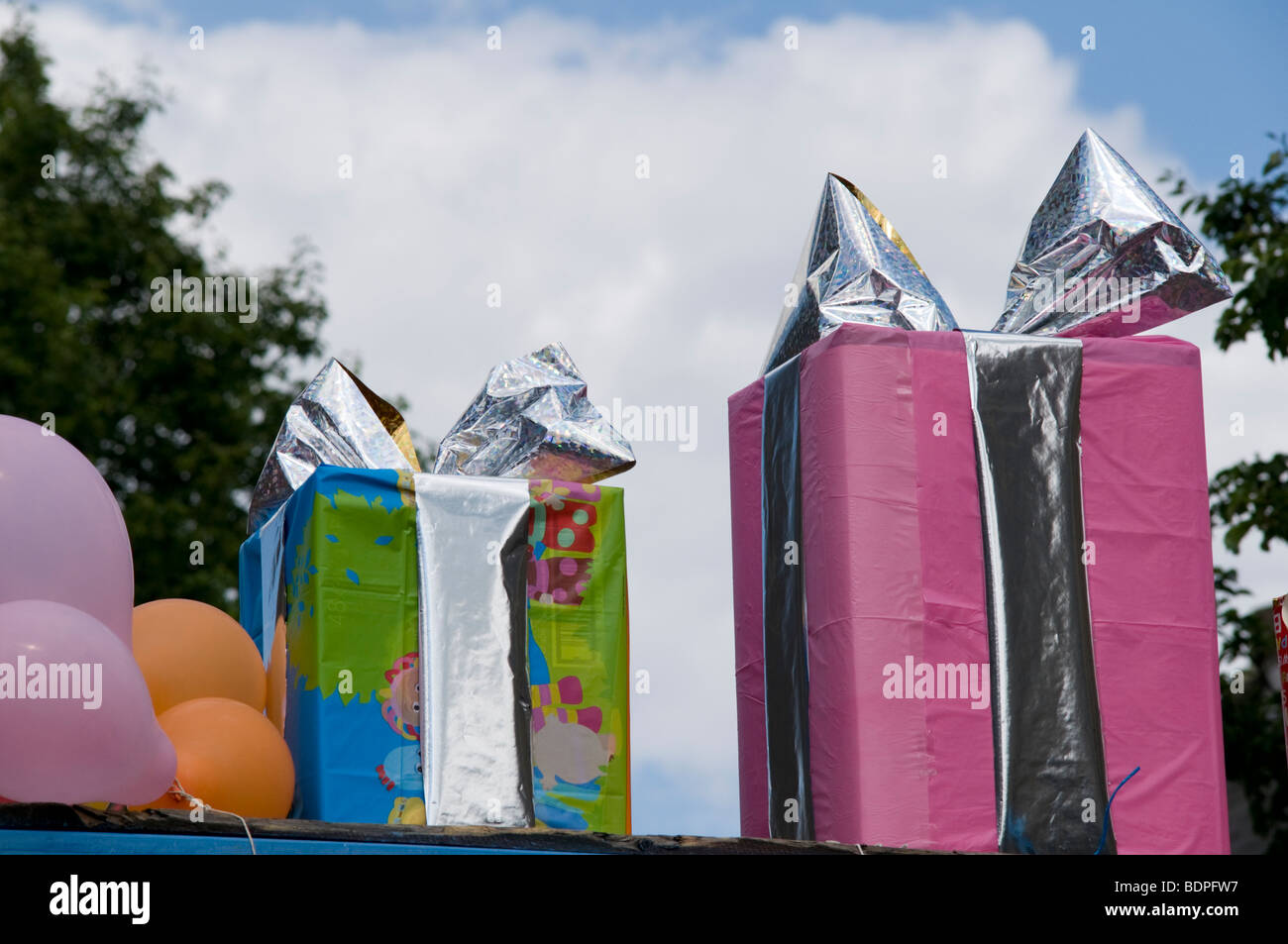 Float of presents and balloons in carnival parade Bakewell Derbyshire ...