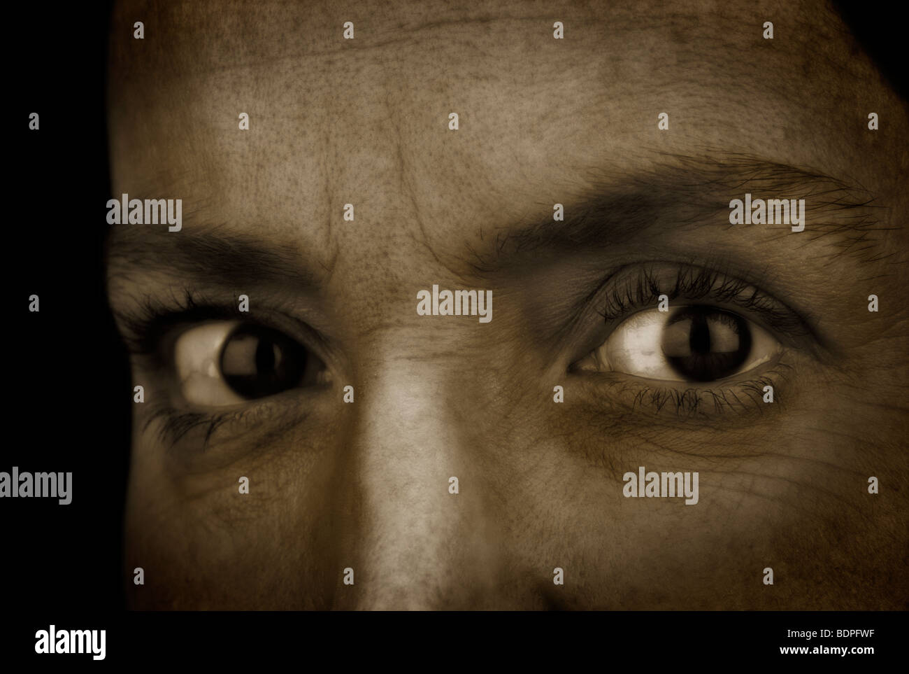 Close up of mans eyes looking worried Stock Photo - Alamy